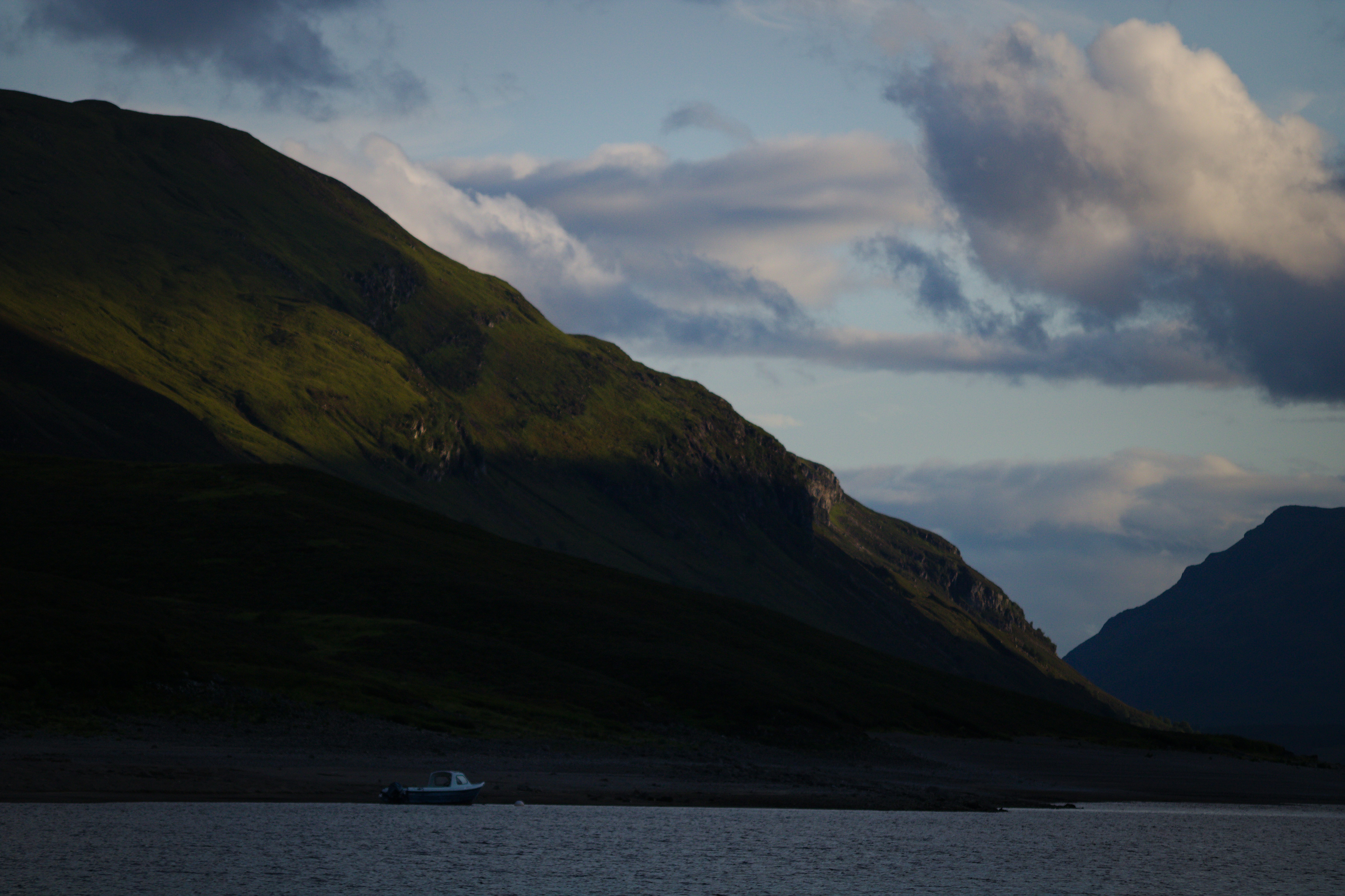 Distant Boat at the Edge of a Mountain Fjord