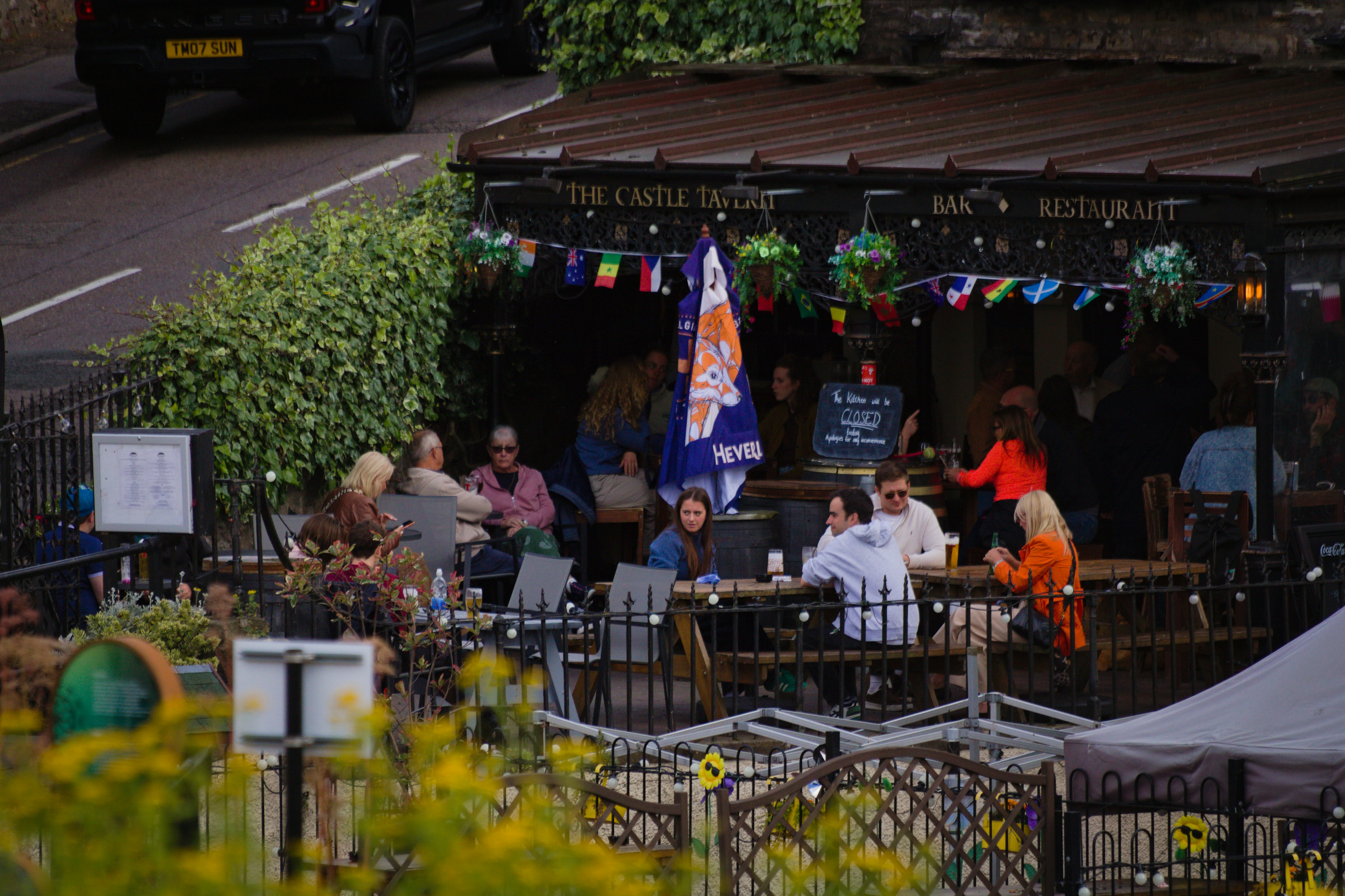 Cafe Lanterns and People Under a Skewered Roof