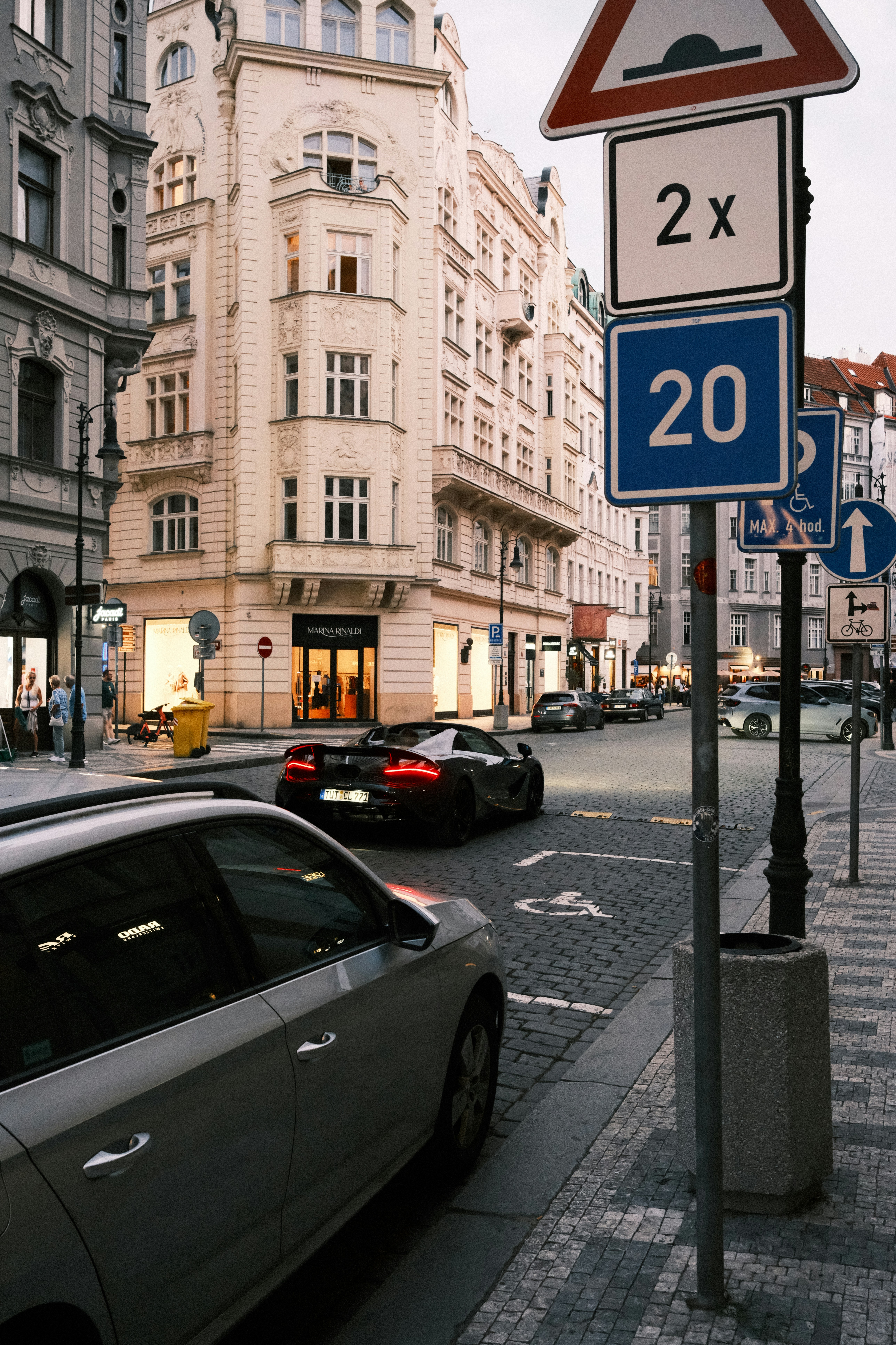 European Street Vista: Cars, Signage, and Historic Facades