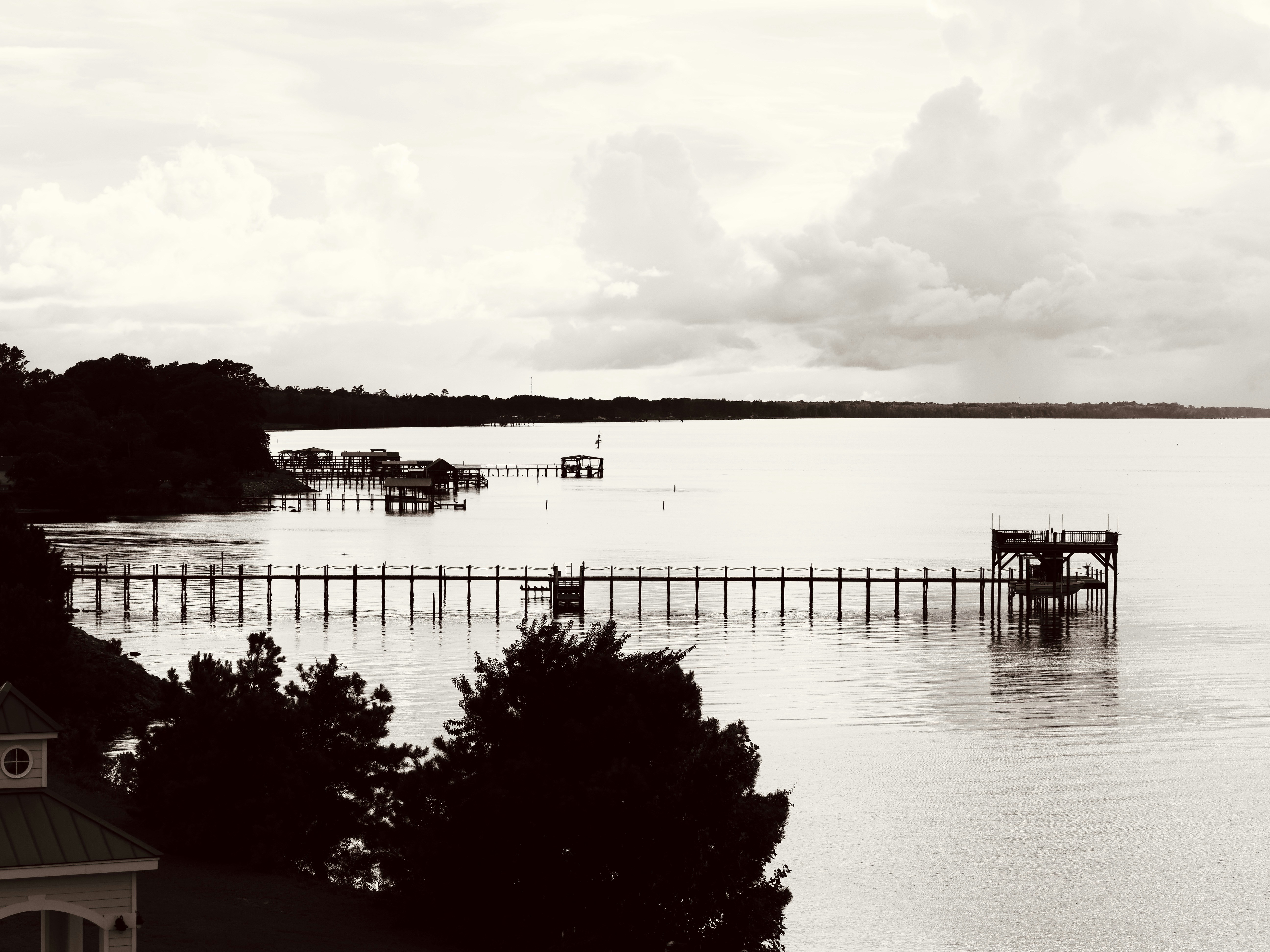 Silhouetted Docks at Dusk Over a Quiet Lake