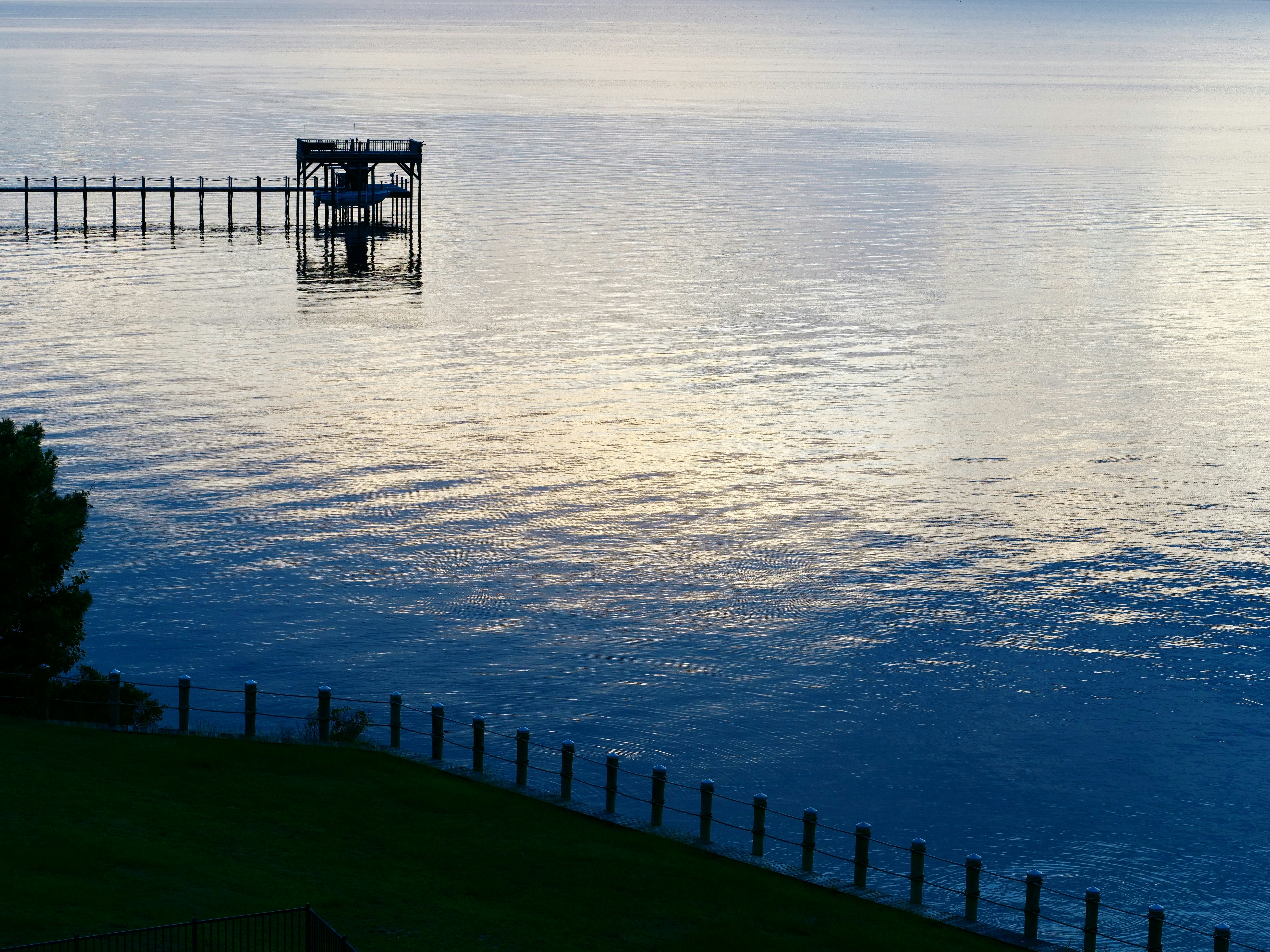 Distant Pier Framing a Quiet Lake at Dusk