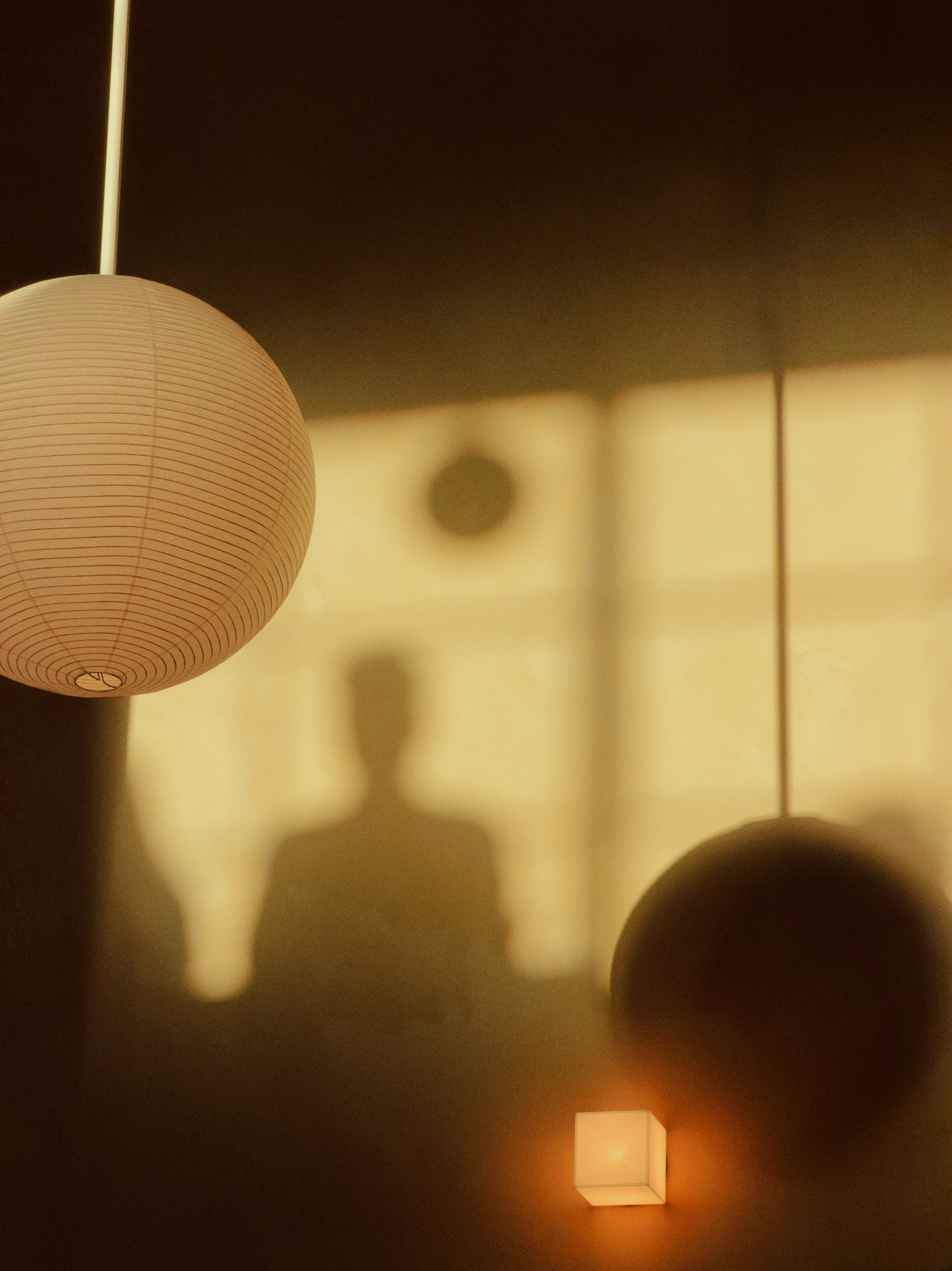 Soft Shadows and Hanging Orbs: Quiet Portrait in a Warm Glow