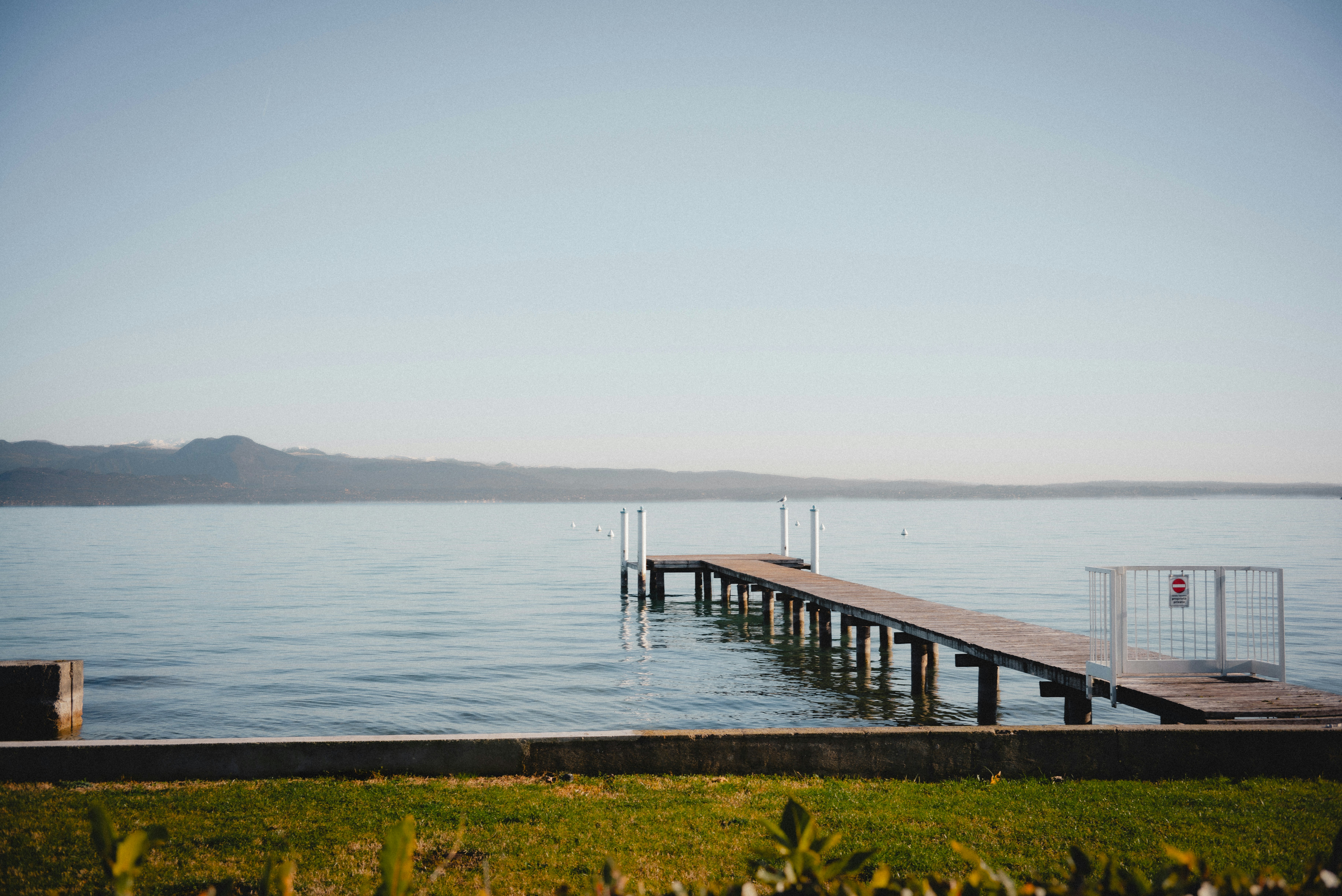 Still Horizon: A Quiet Pier Embraced by Calm Water
