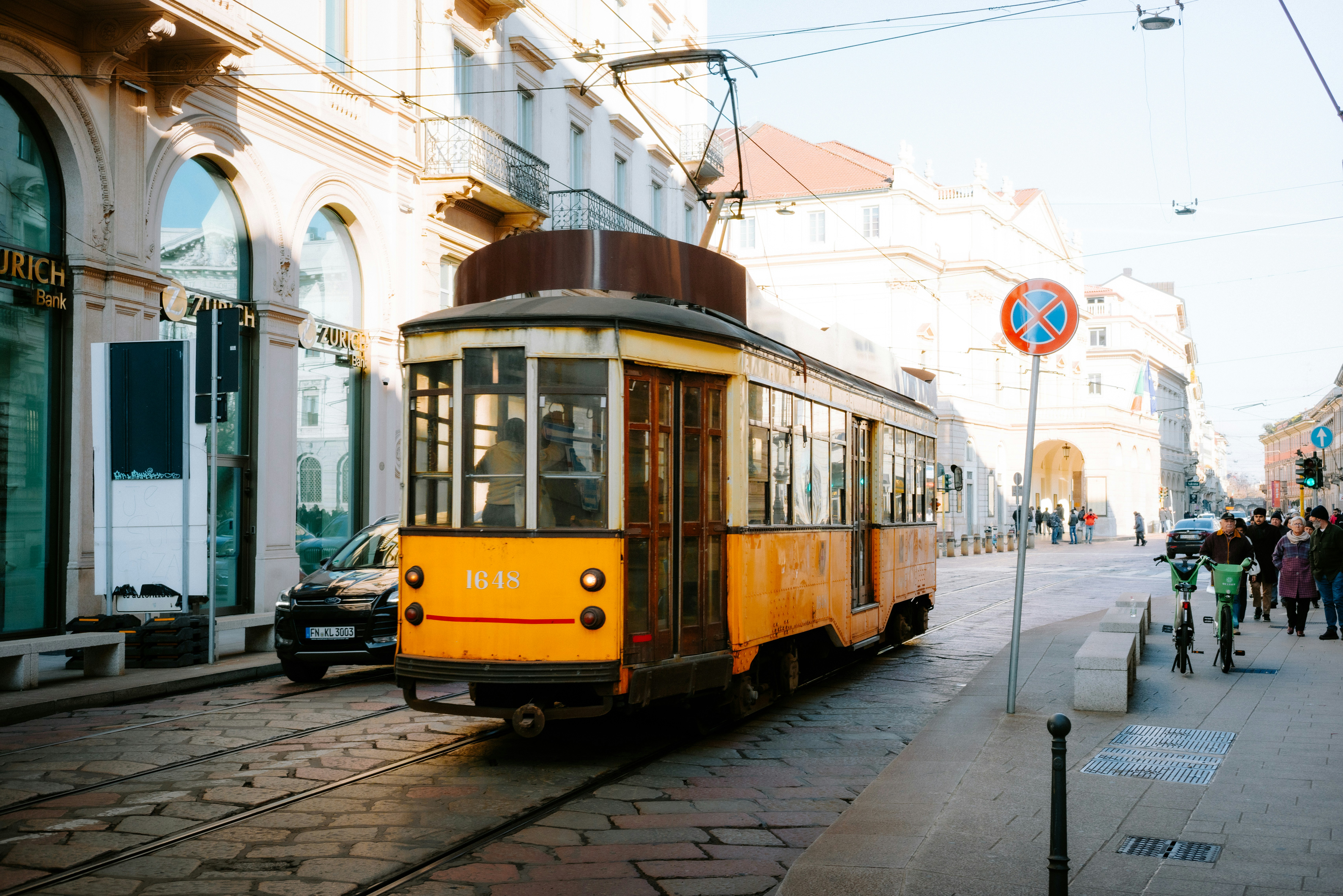 Amber Streetcar on a Sunlit European Avenue