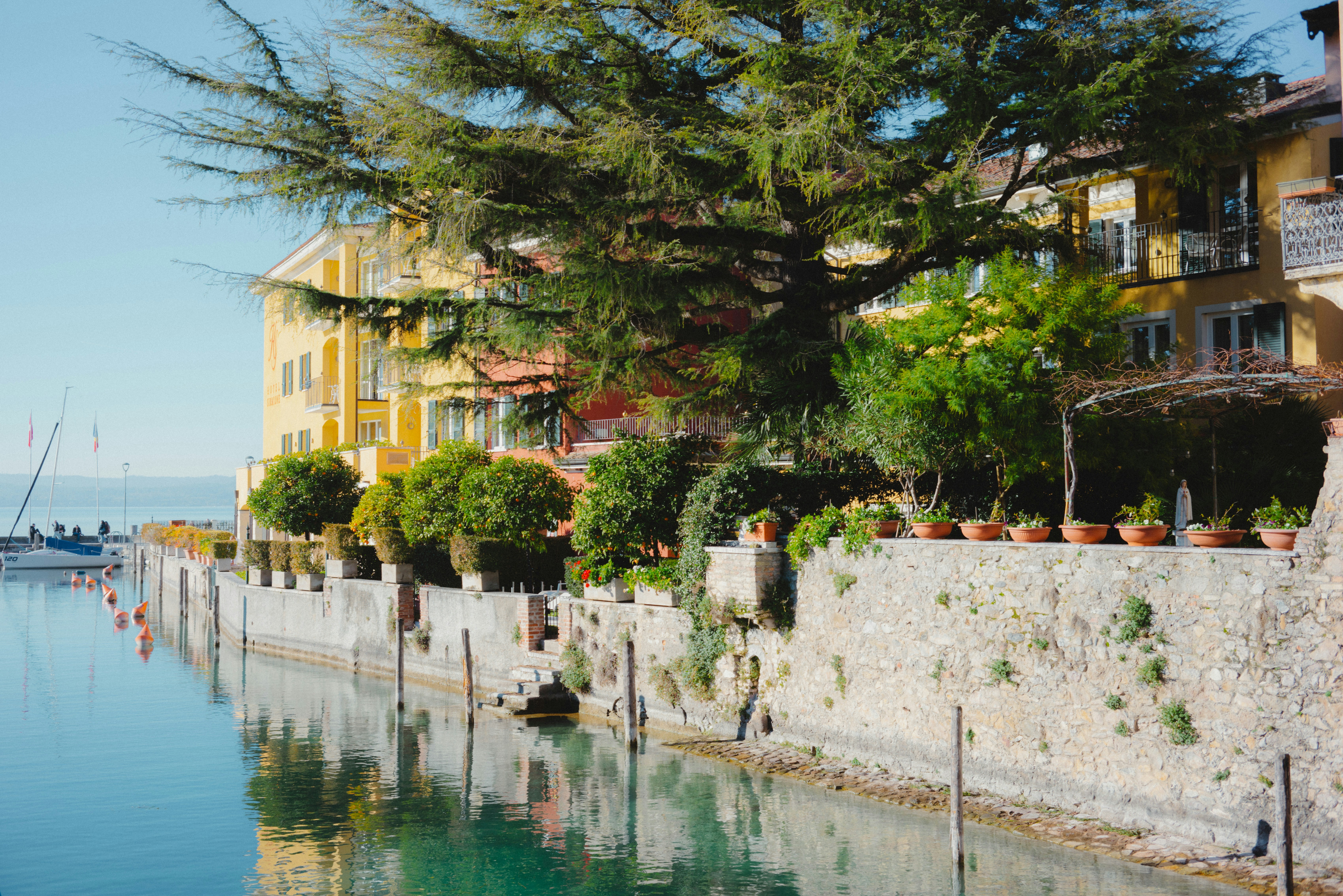 Sunlit Mediterranean Canalfront with Terraced Lemon Trees