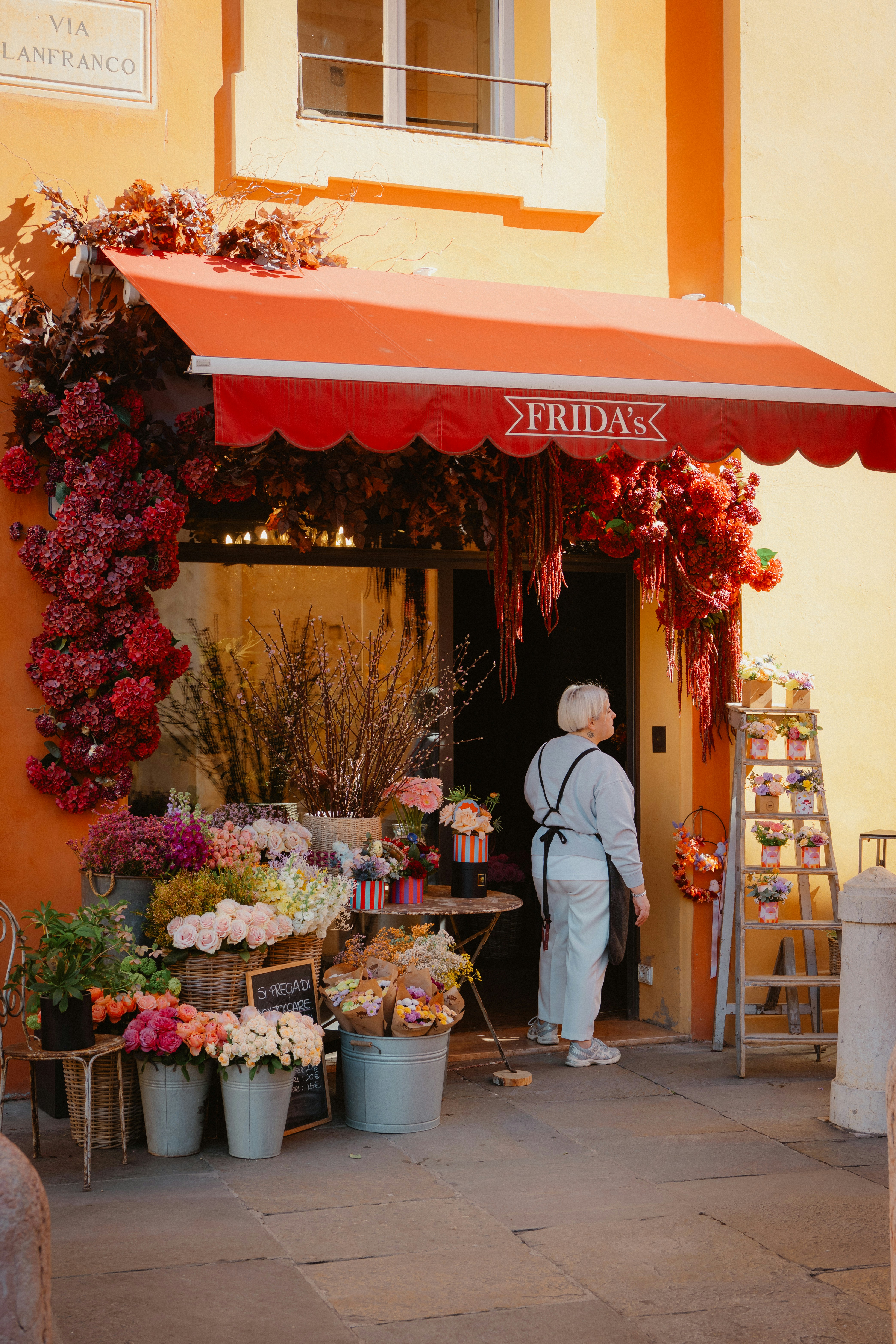 Vibrant Florist Opera: A Bougainvillea-strewn storefront with a silver-haired shopper