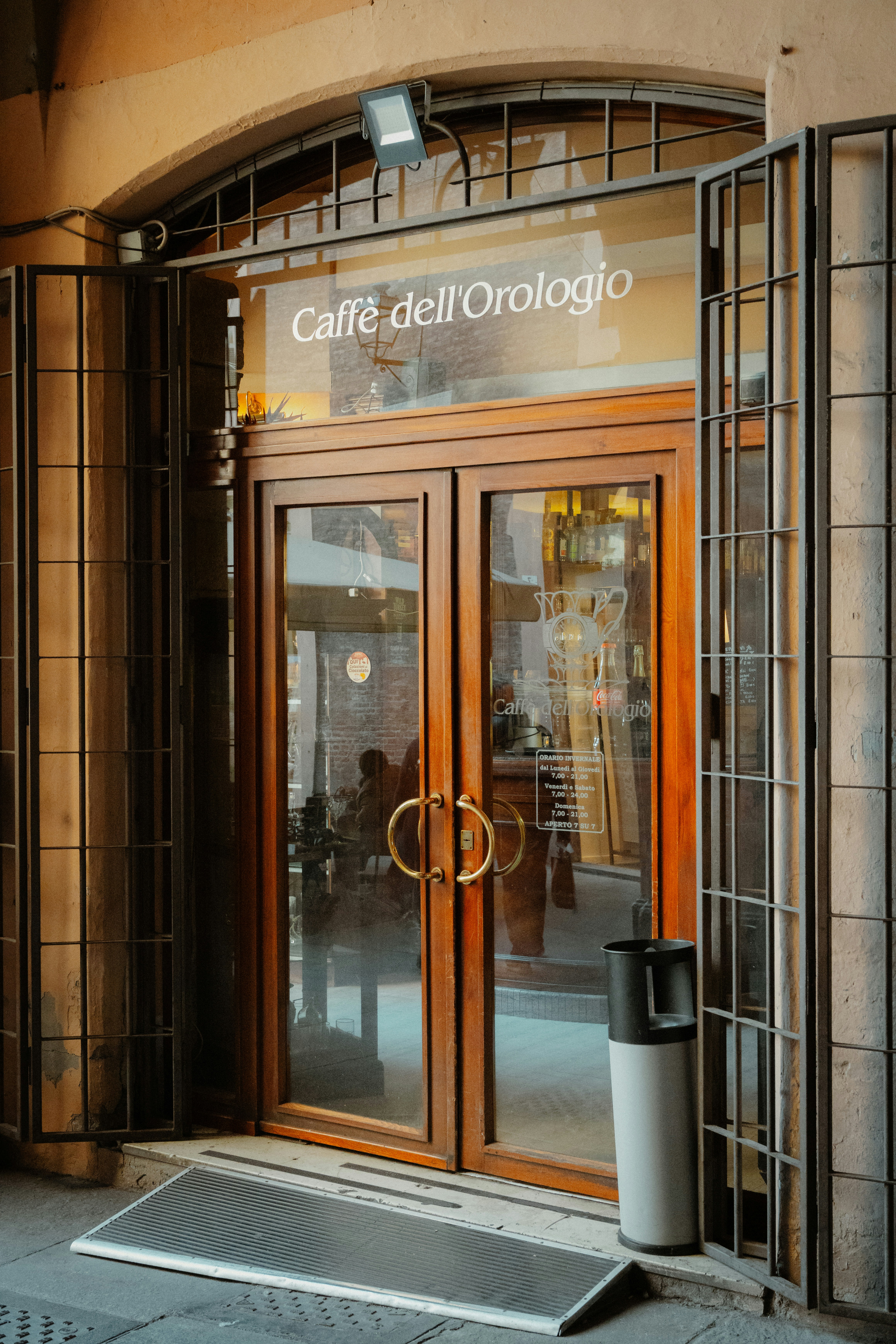 Open Doors to a Quiet Café: Warm Wood and Iron Framing