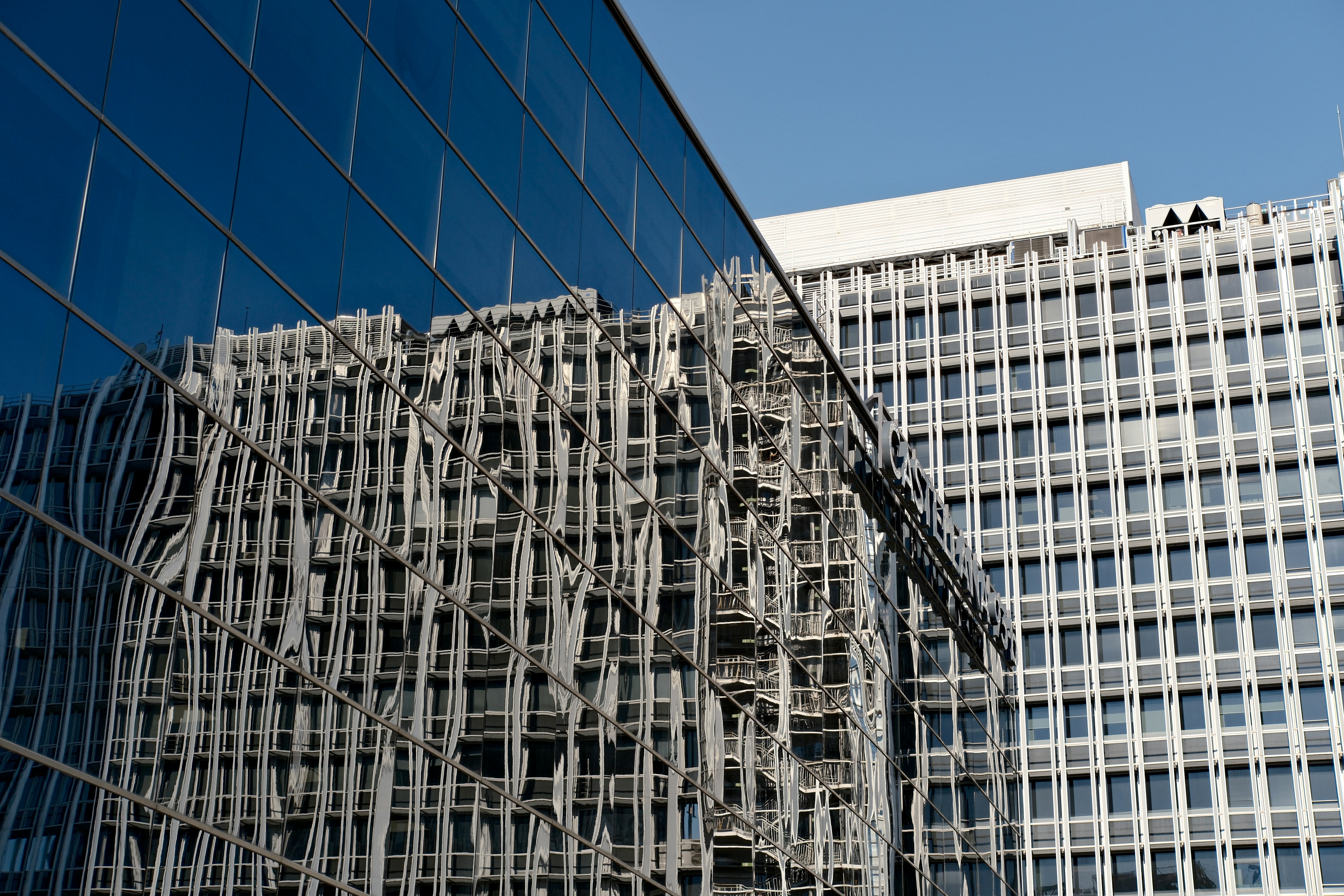 Glass Facade Reflections Framing a Geometric Skyline