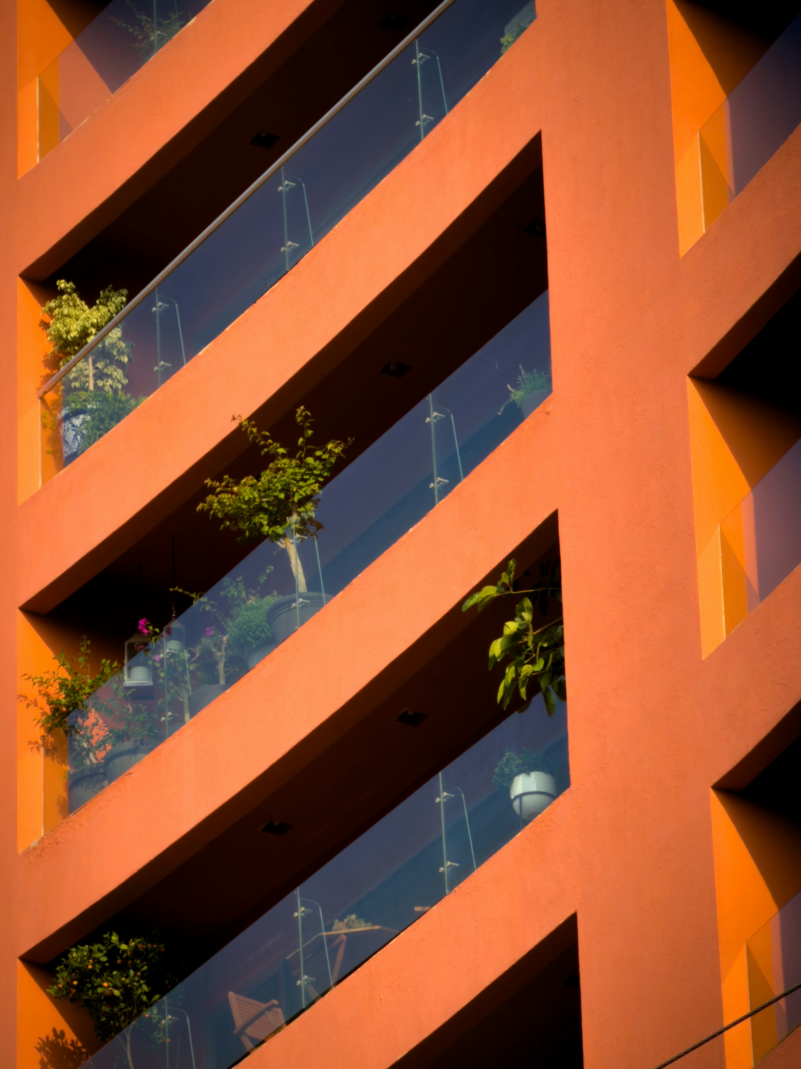 Sunlit orange balconies tracing geometric light and shadow