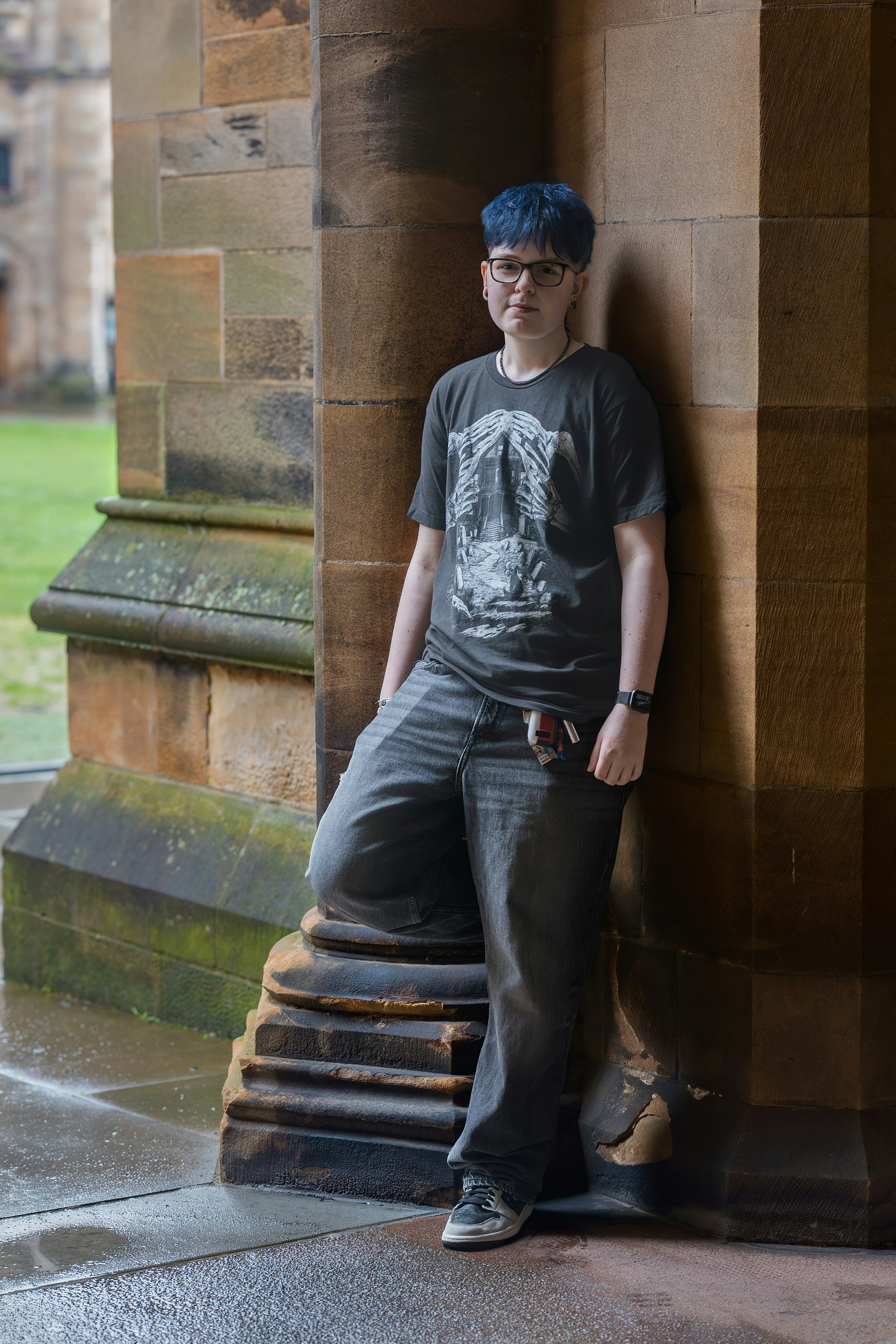 Portrait under Stone Arches: Casual Confidence in Shadowed Columns