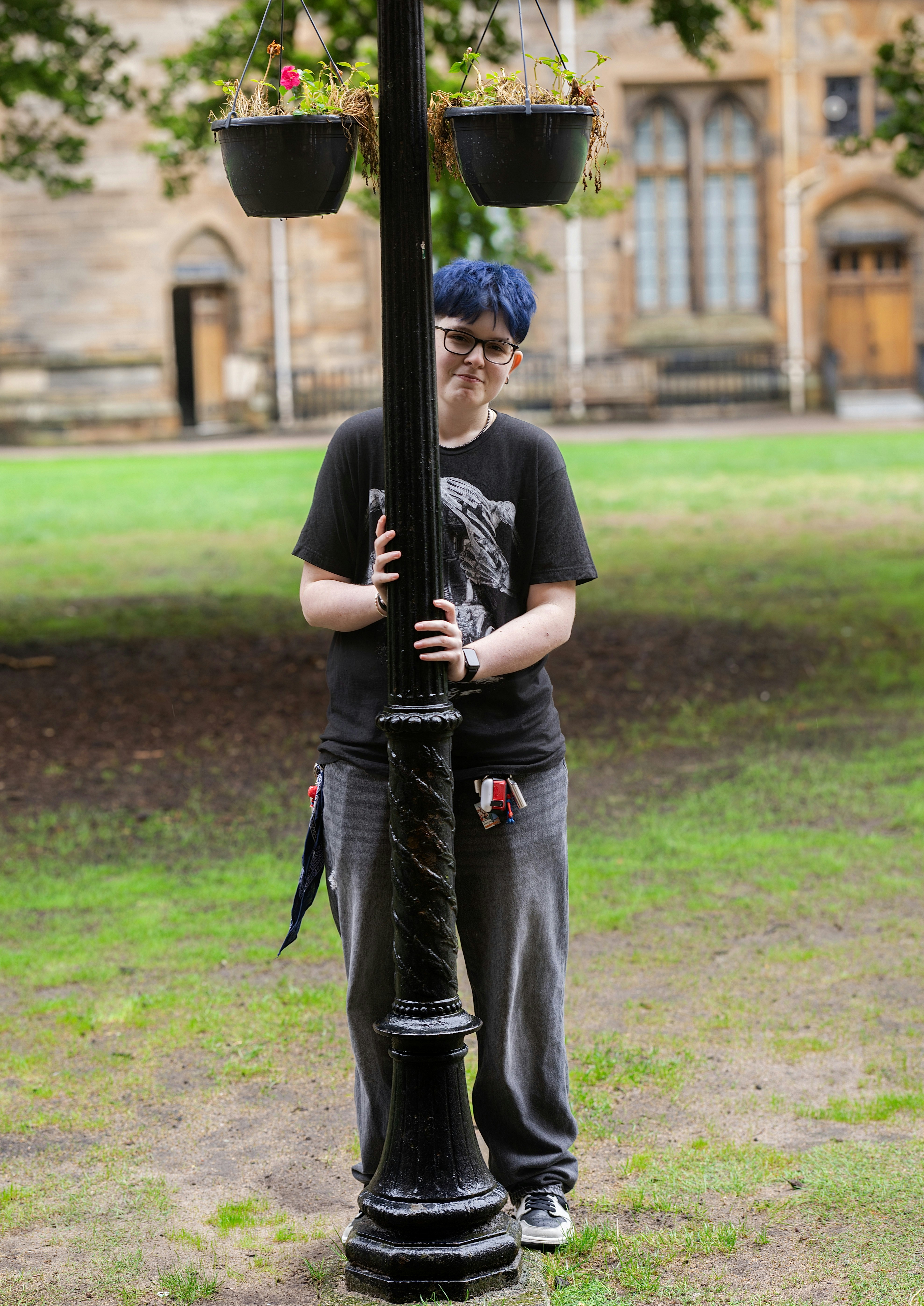 Holding the Old Lantern: A Quiet Portrait at the Park Gate