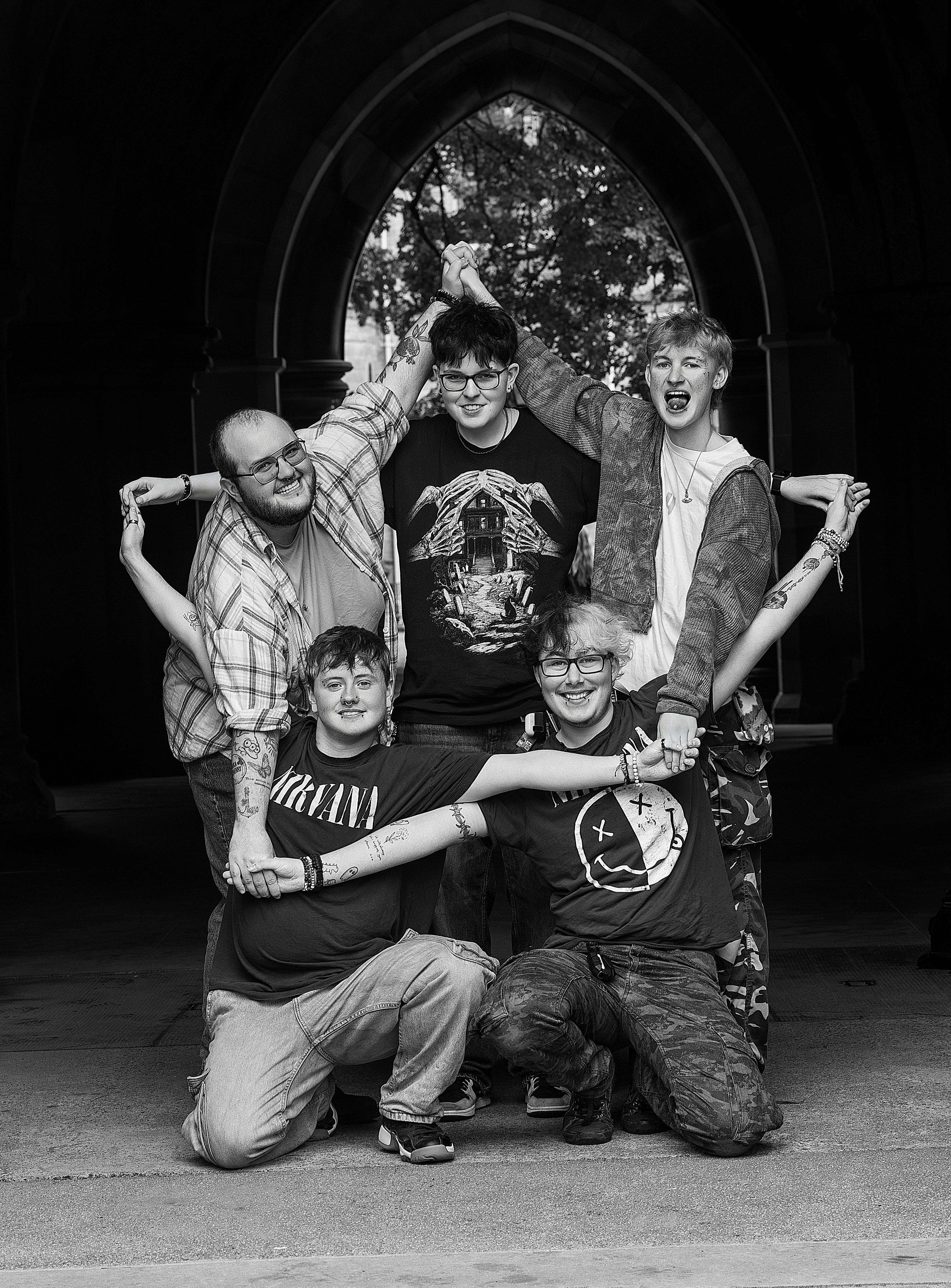 Unity Under Arch: A Grinning Band in a Shadowed Archway