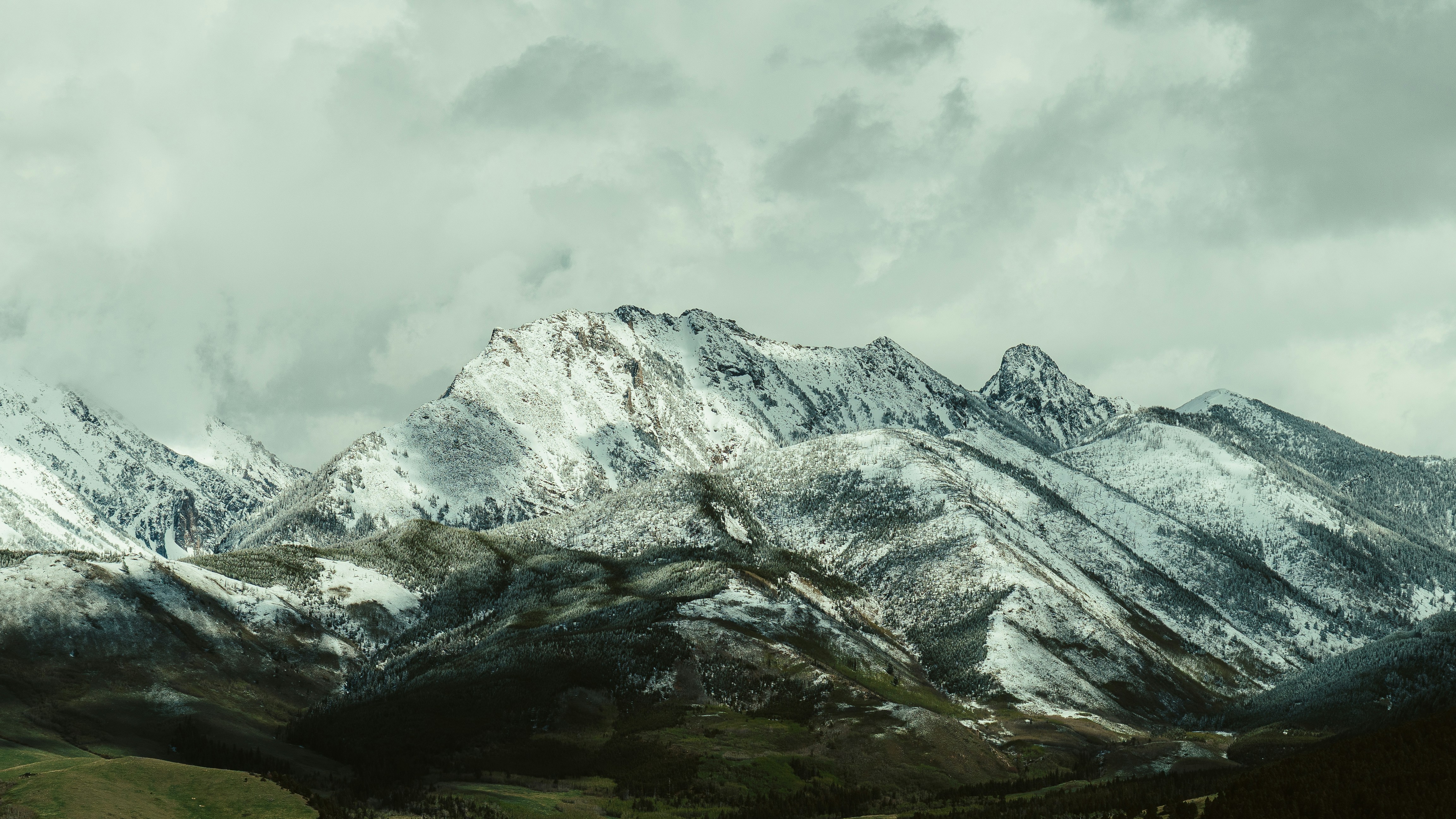 Snow-Capped Ridge under Stormy Sky