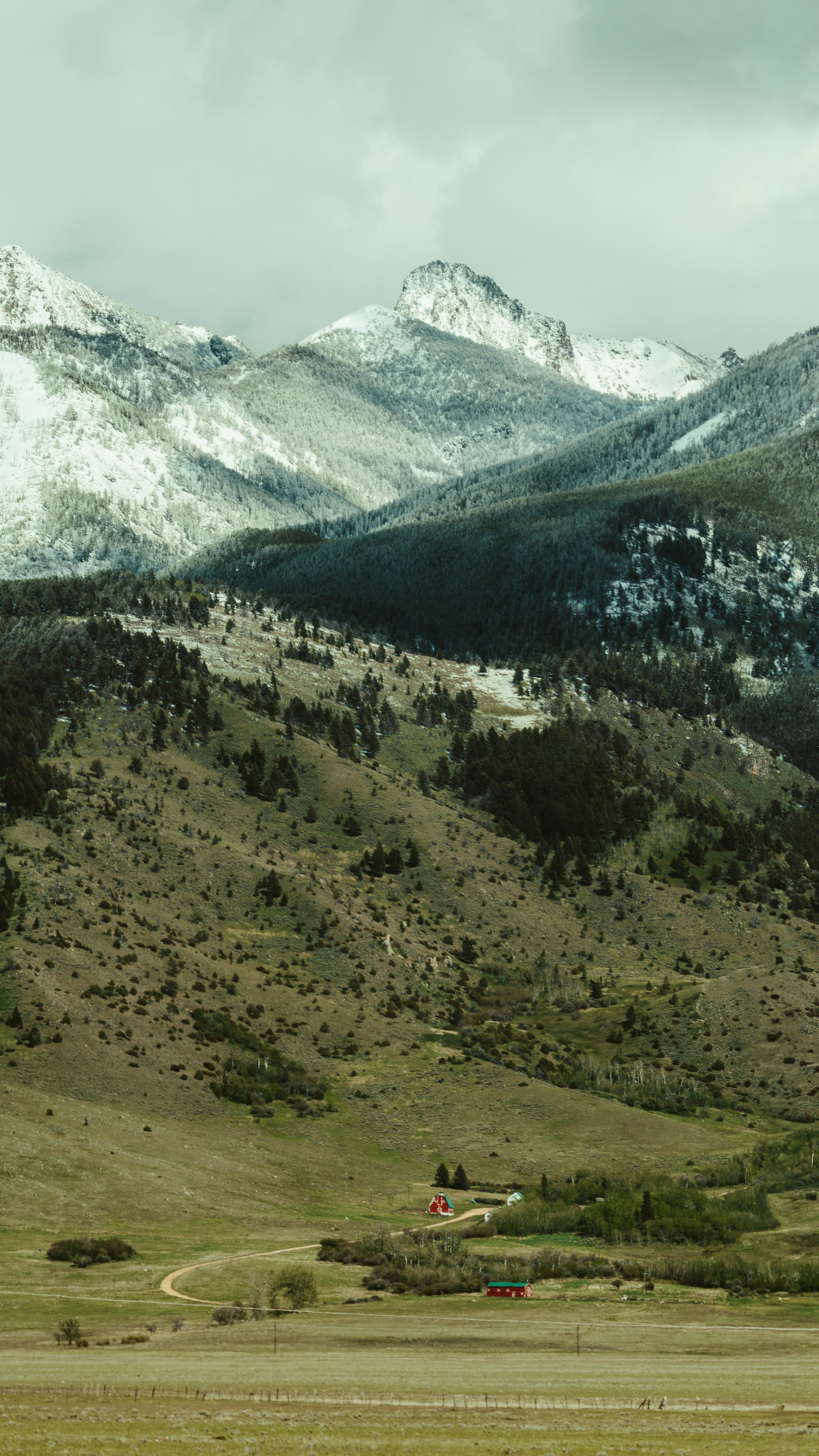 Snow-kissed Peaks Over a Quiet Mountain Valley