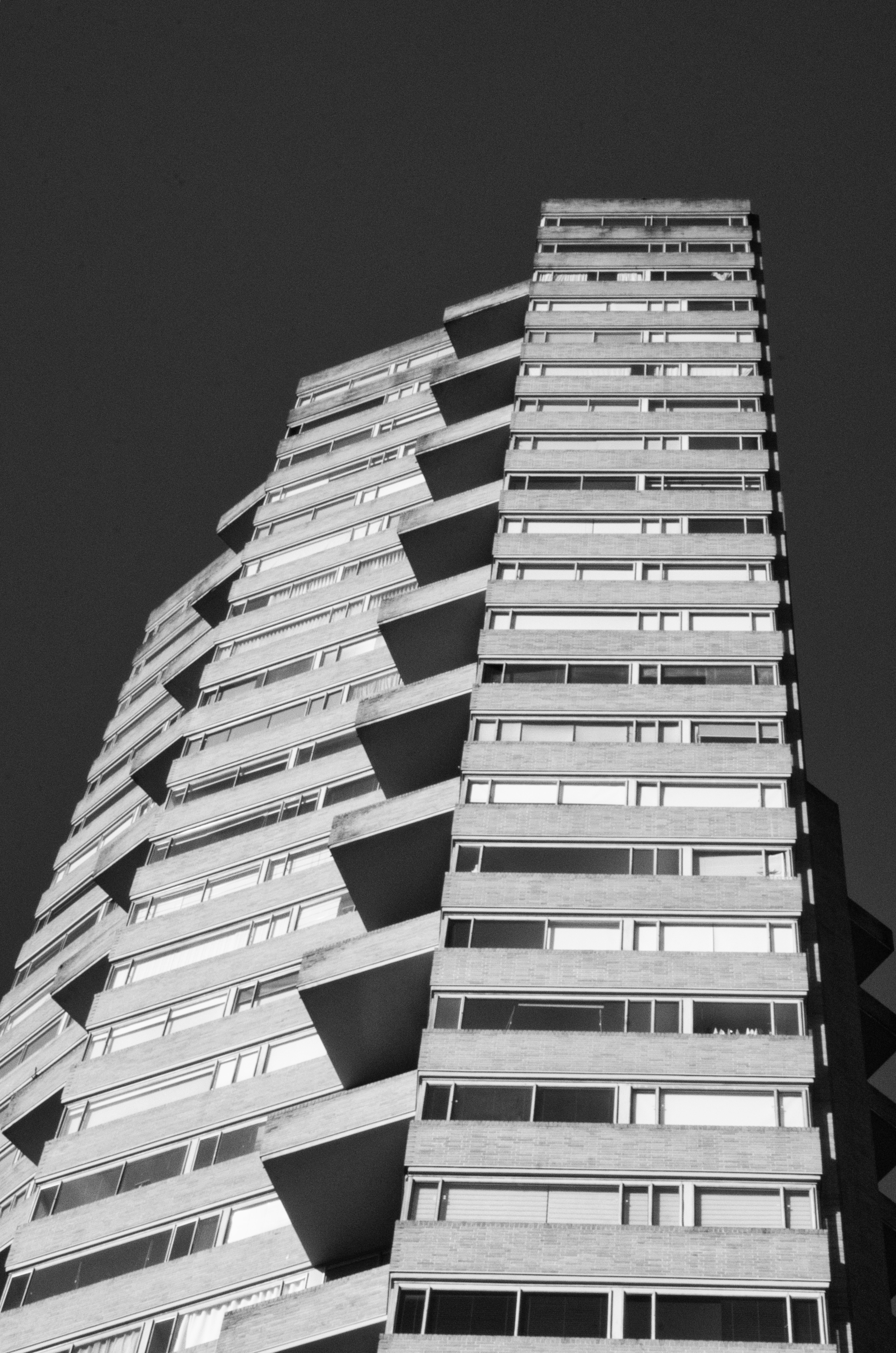 Vertical Strata: A Monochrome Facade Rising Against the Sky