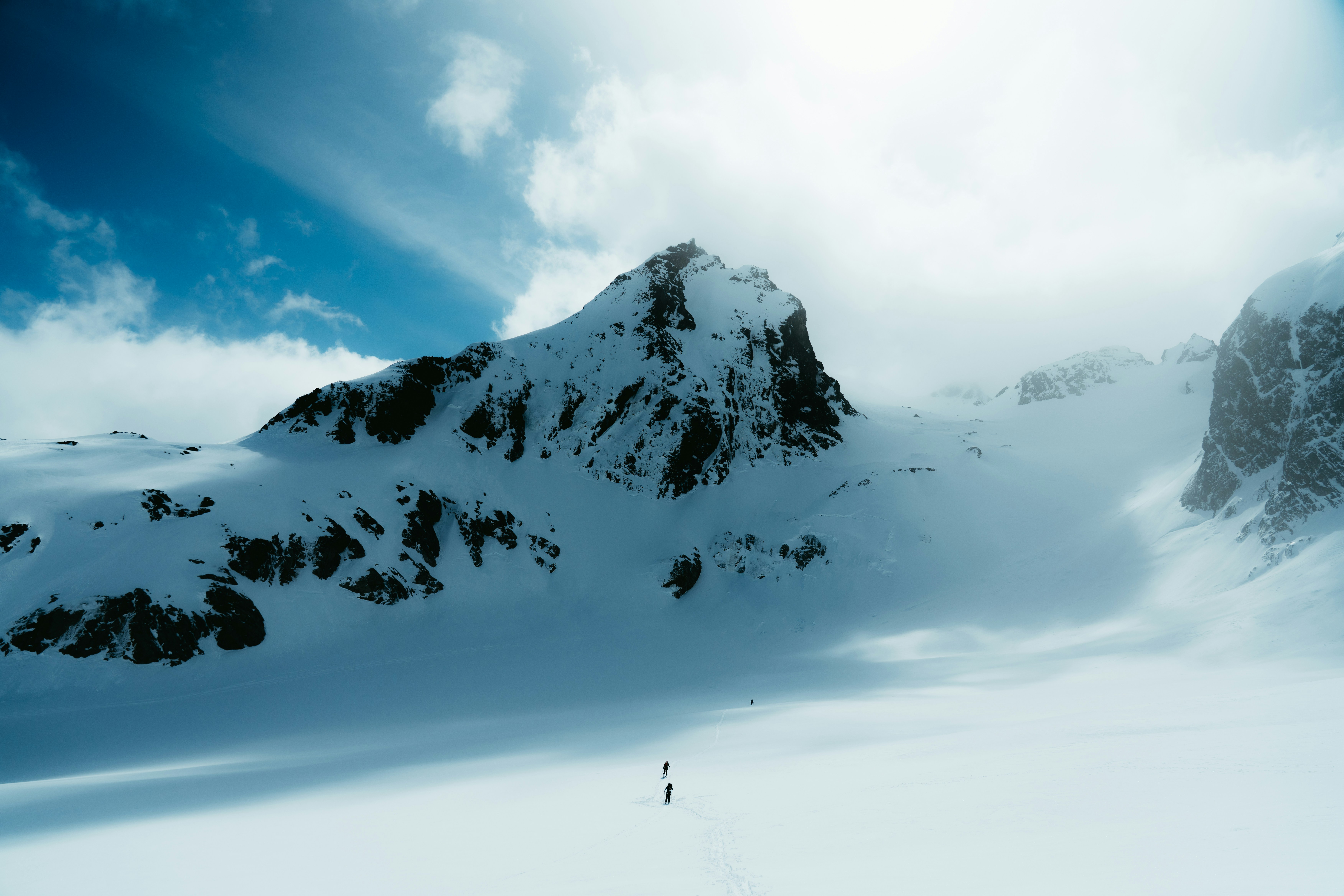 Snowbound Sentinel: A Lone Trekker Before the Alpine Expanse