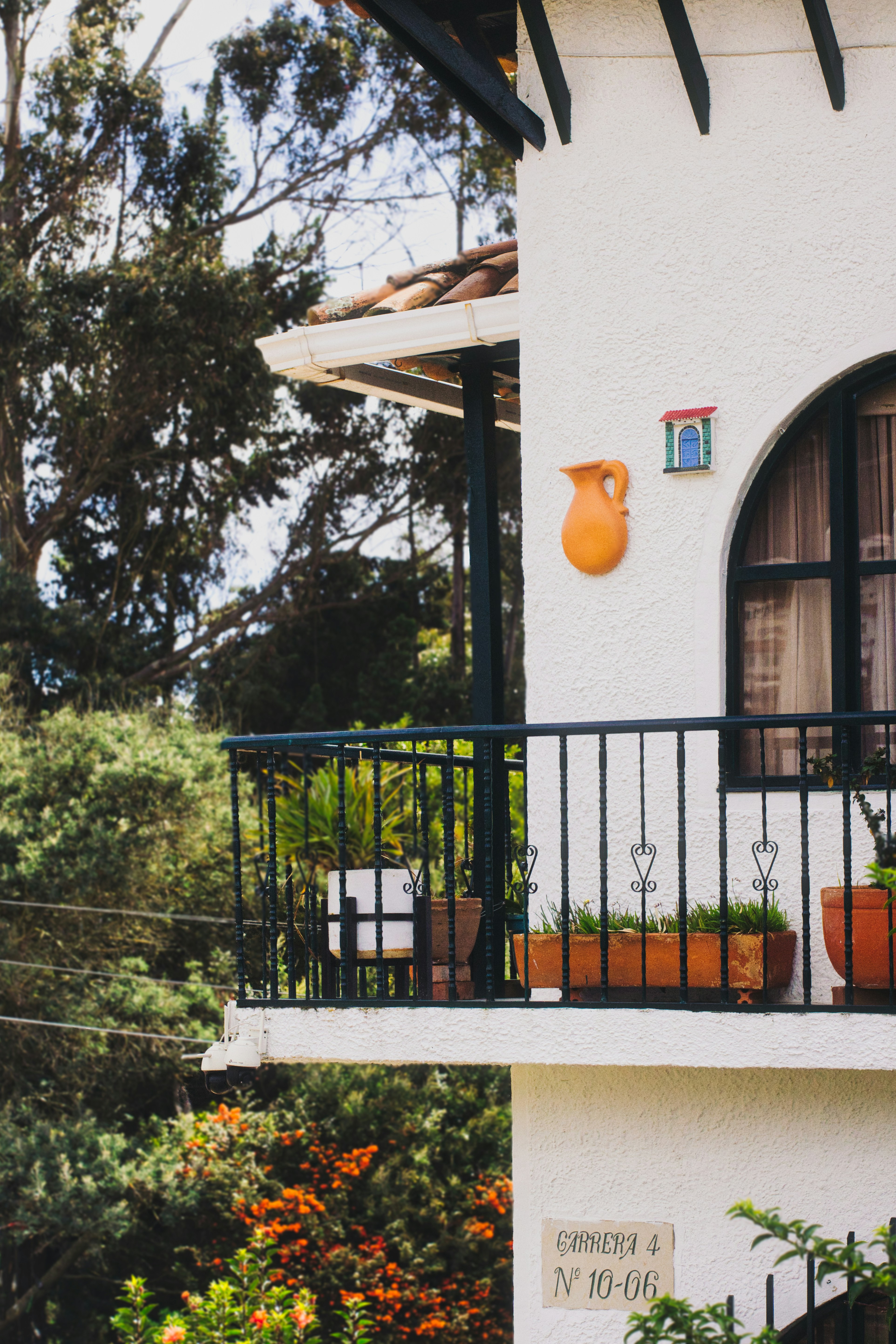 Terraced villa balcony with terracotta details and garden beyond