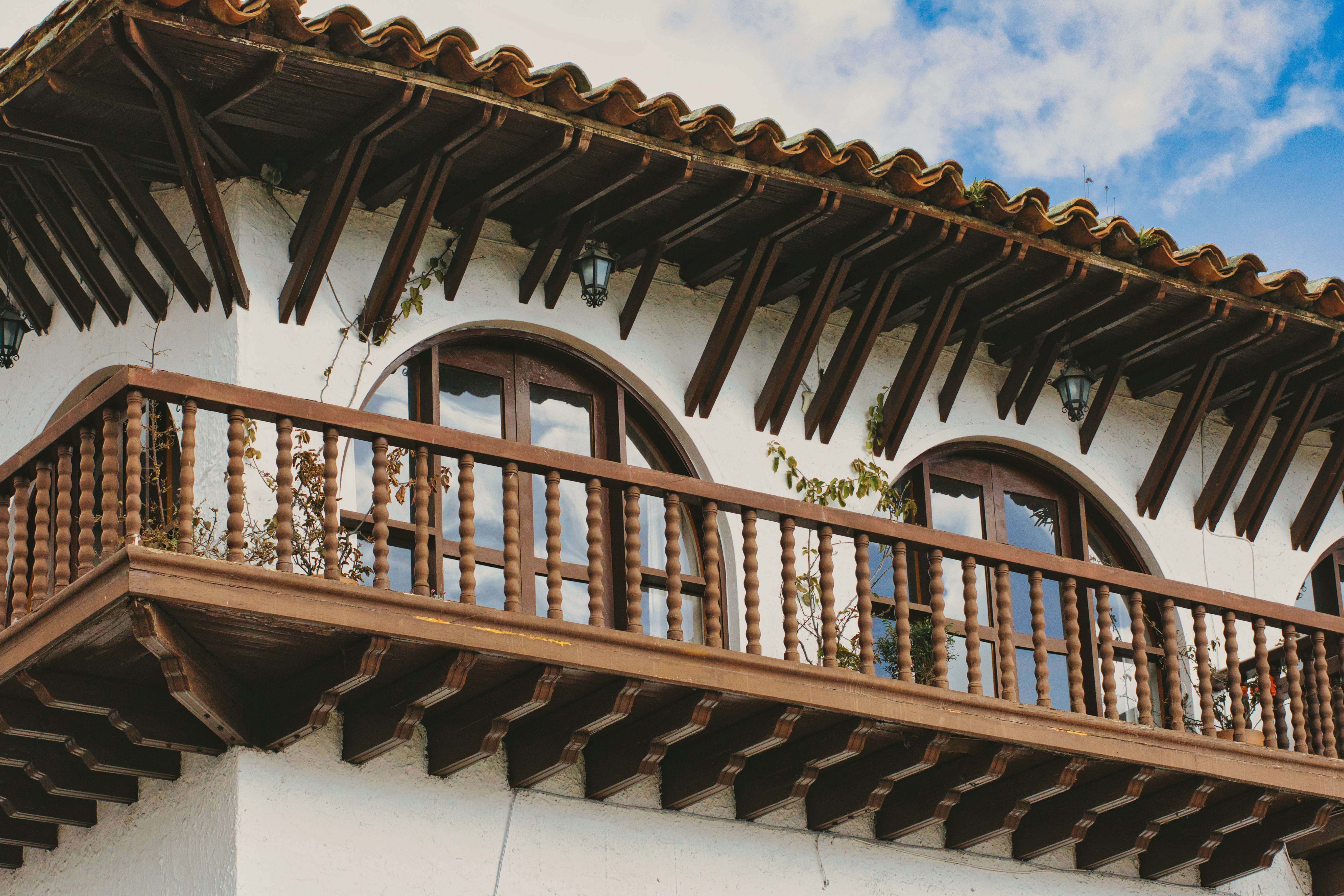 Balcony Overhang with Arched Windows