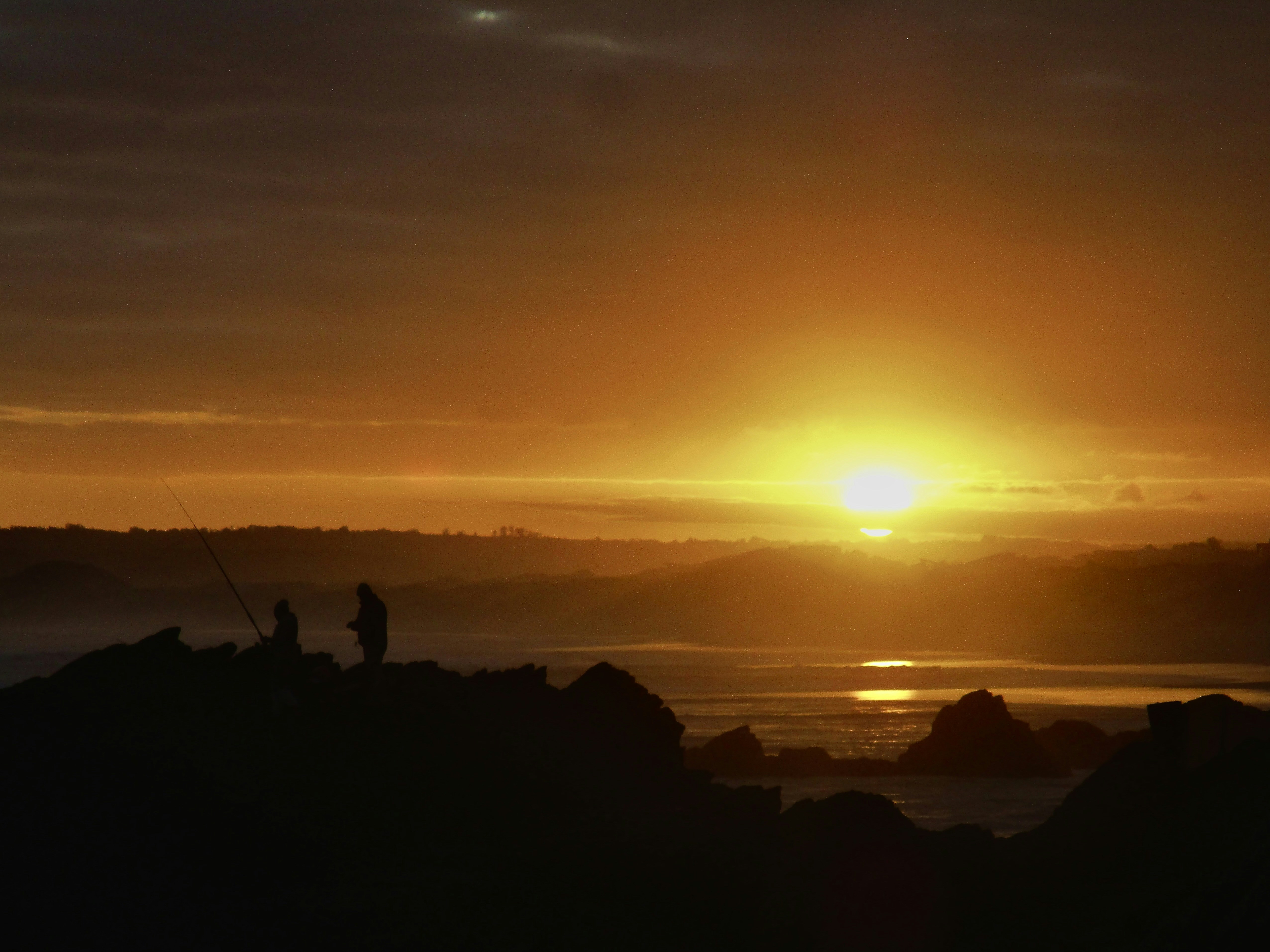 Golden Horizon: Silhouetted Angler at Sundown