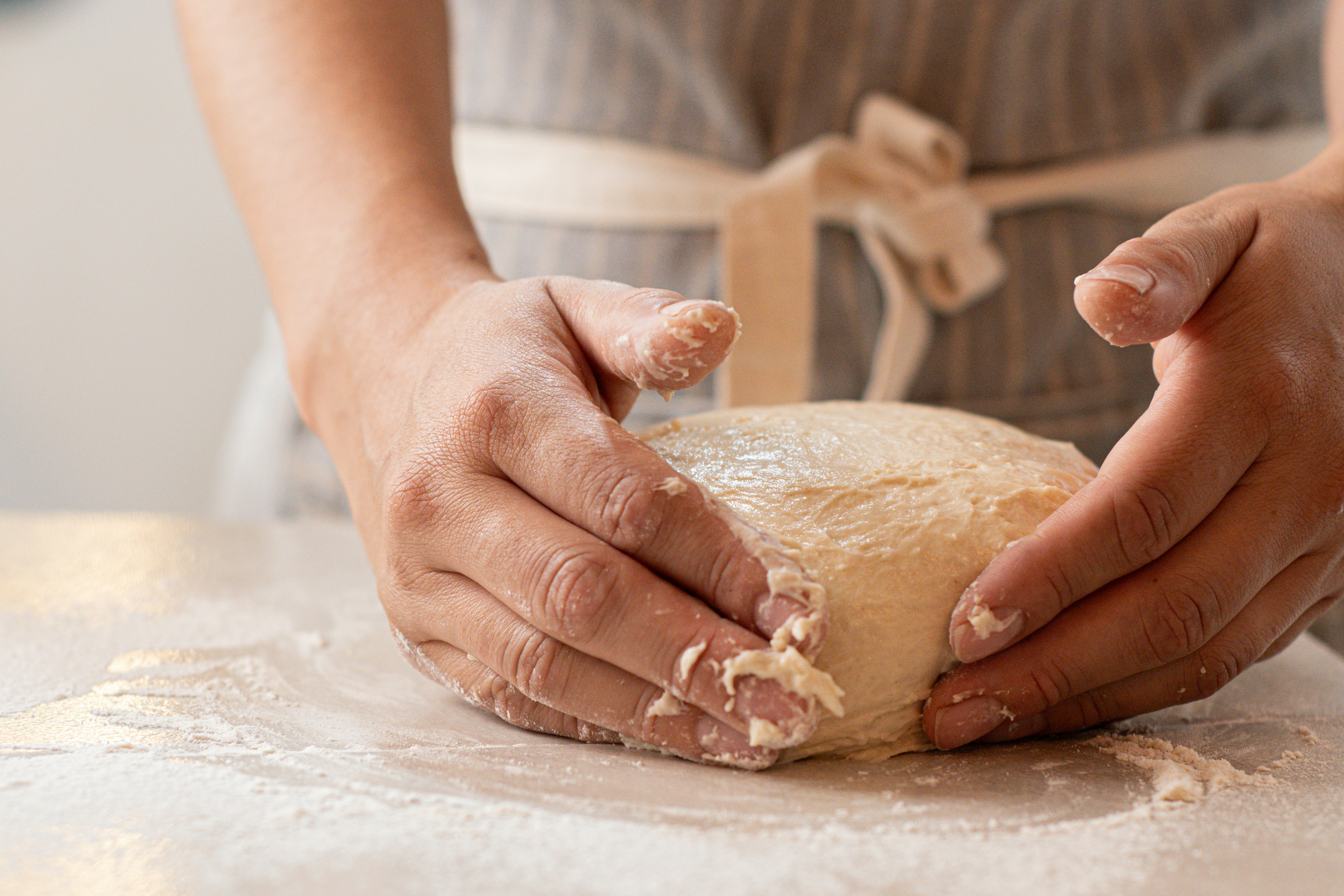 Kneading Dough: Hands Working Softly Through Flour Dust