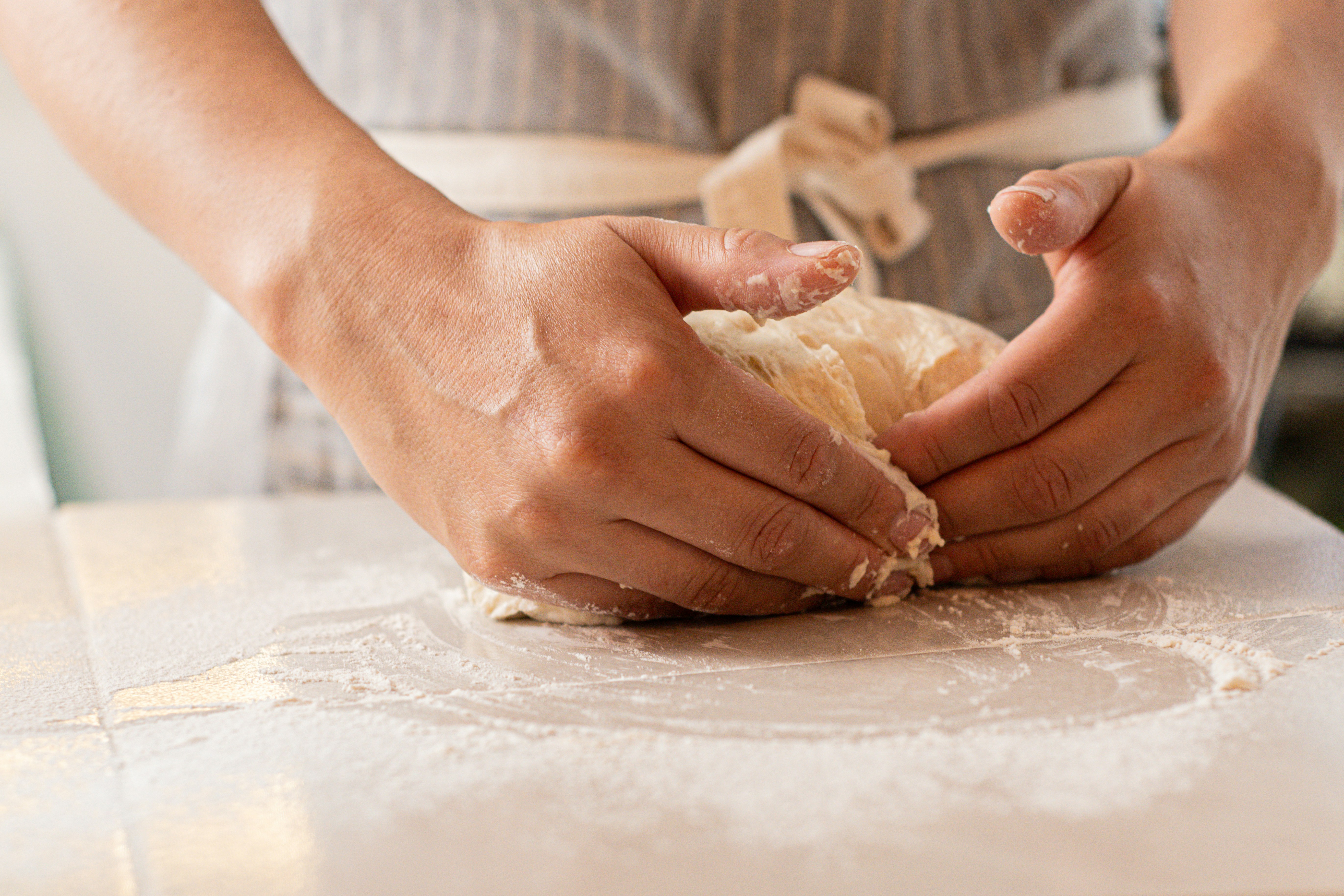 Kneading Hands: Crafting Dough on a Quiet Kitchen Counter