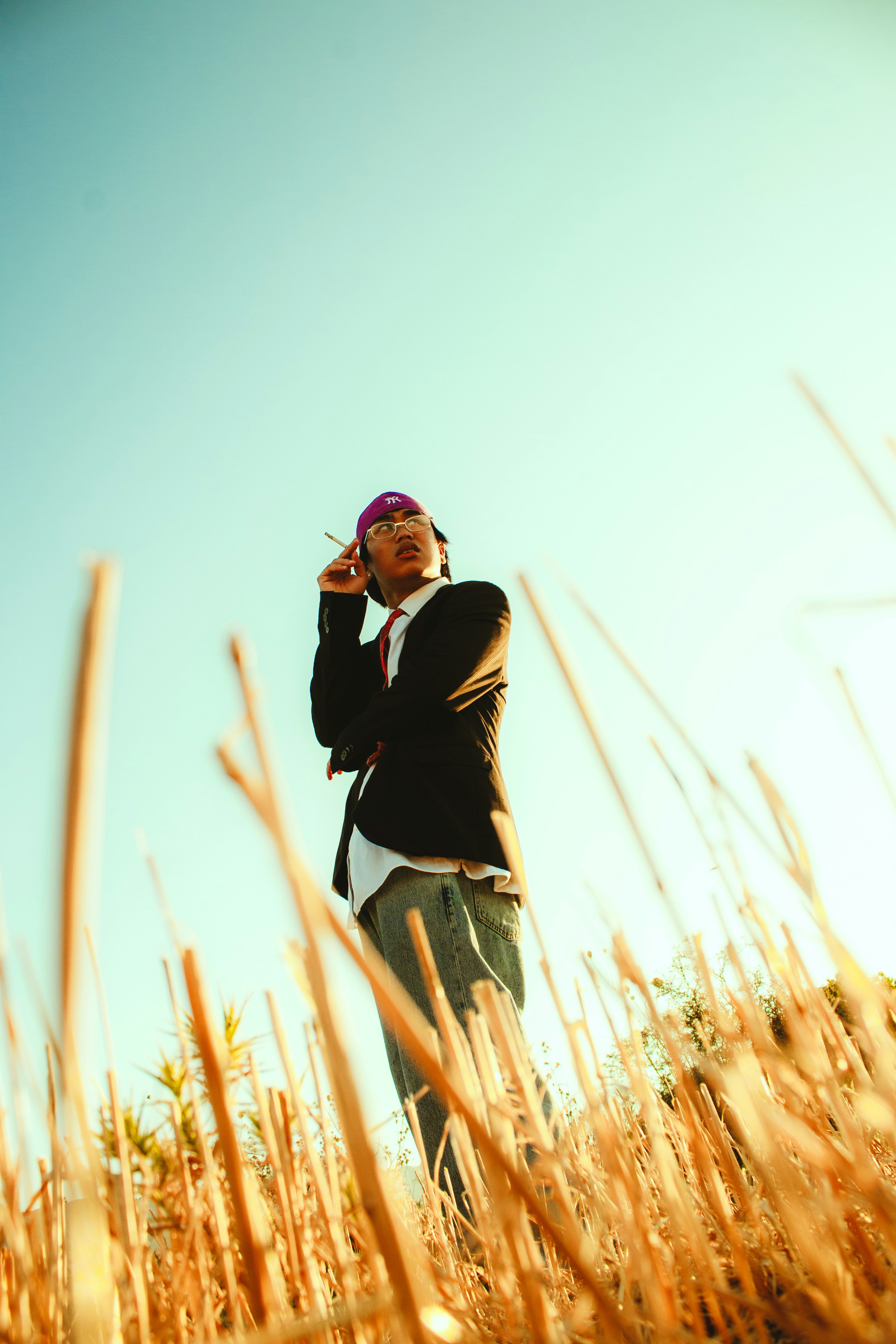 Solemn Confidence: A Suit-Clad Figure Amid Tall Golden Grass