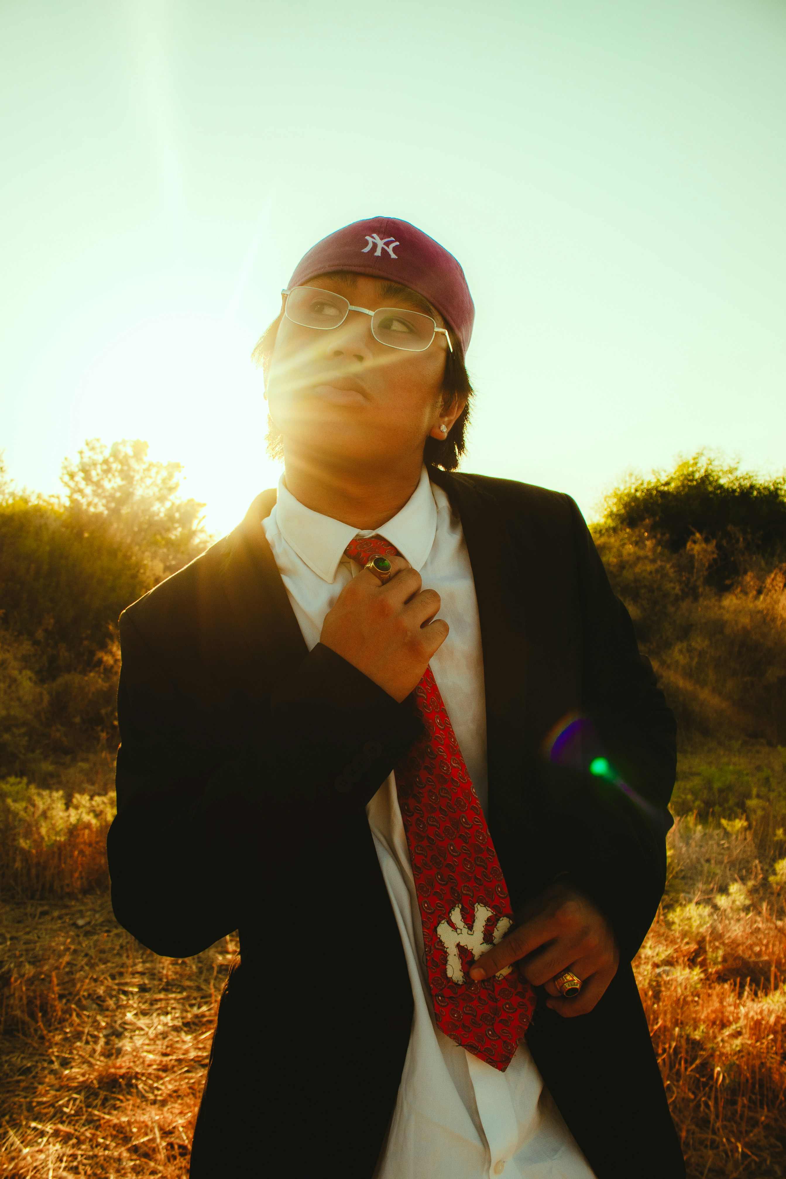 Sunlit Confidence: A Suit, A Tie, and a Bold Stare