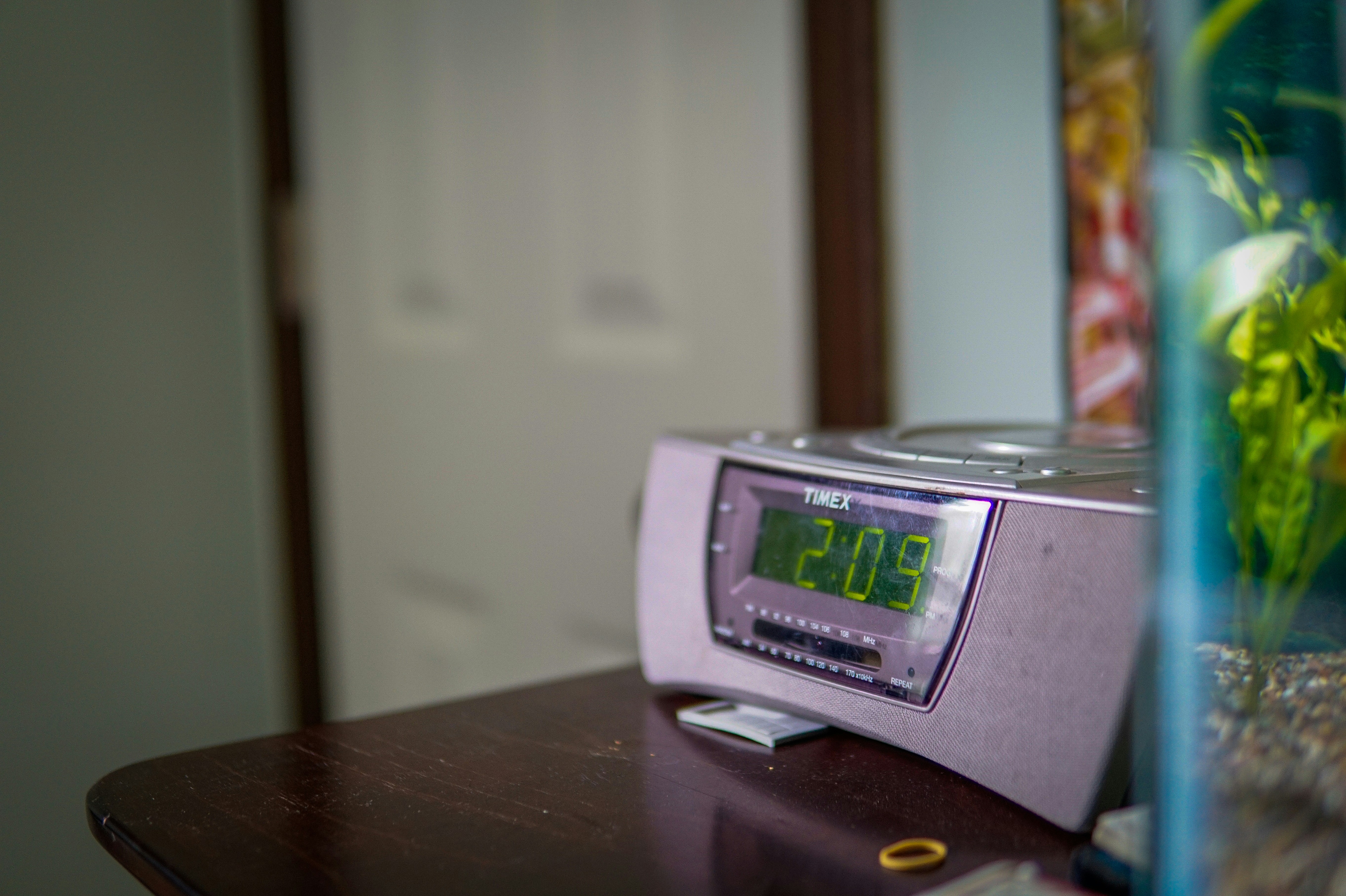 Sleek digital clock radio on a wooden desk at dawn