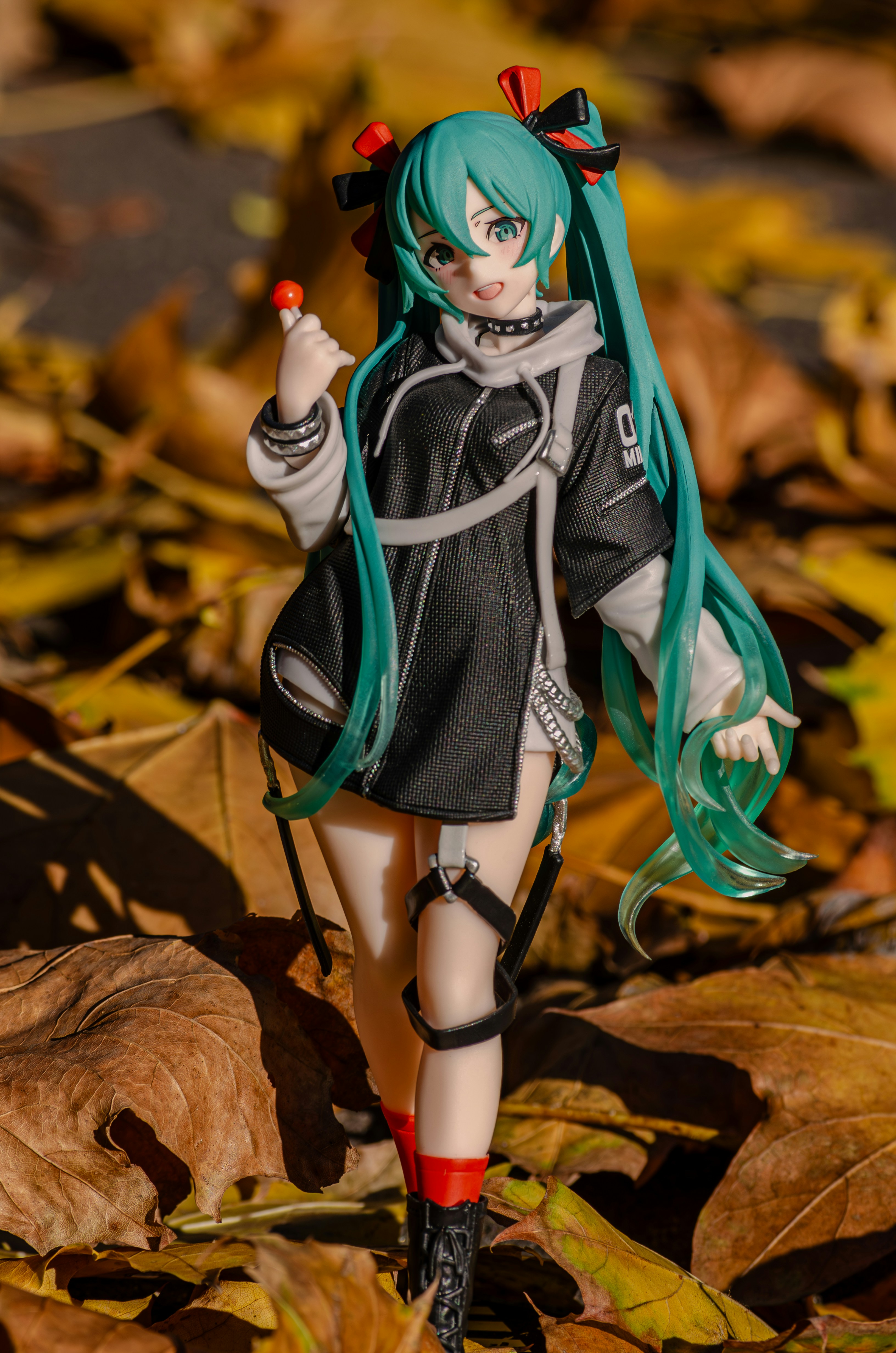Likeness in Leaves: Hatsune Miku Figurine Amid Autumn Cloak