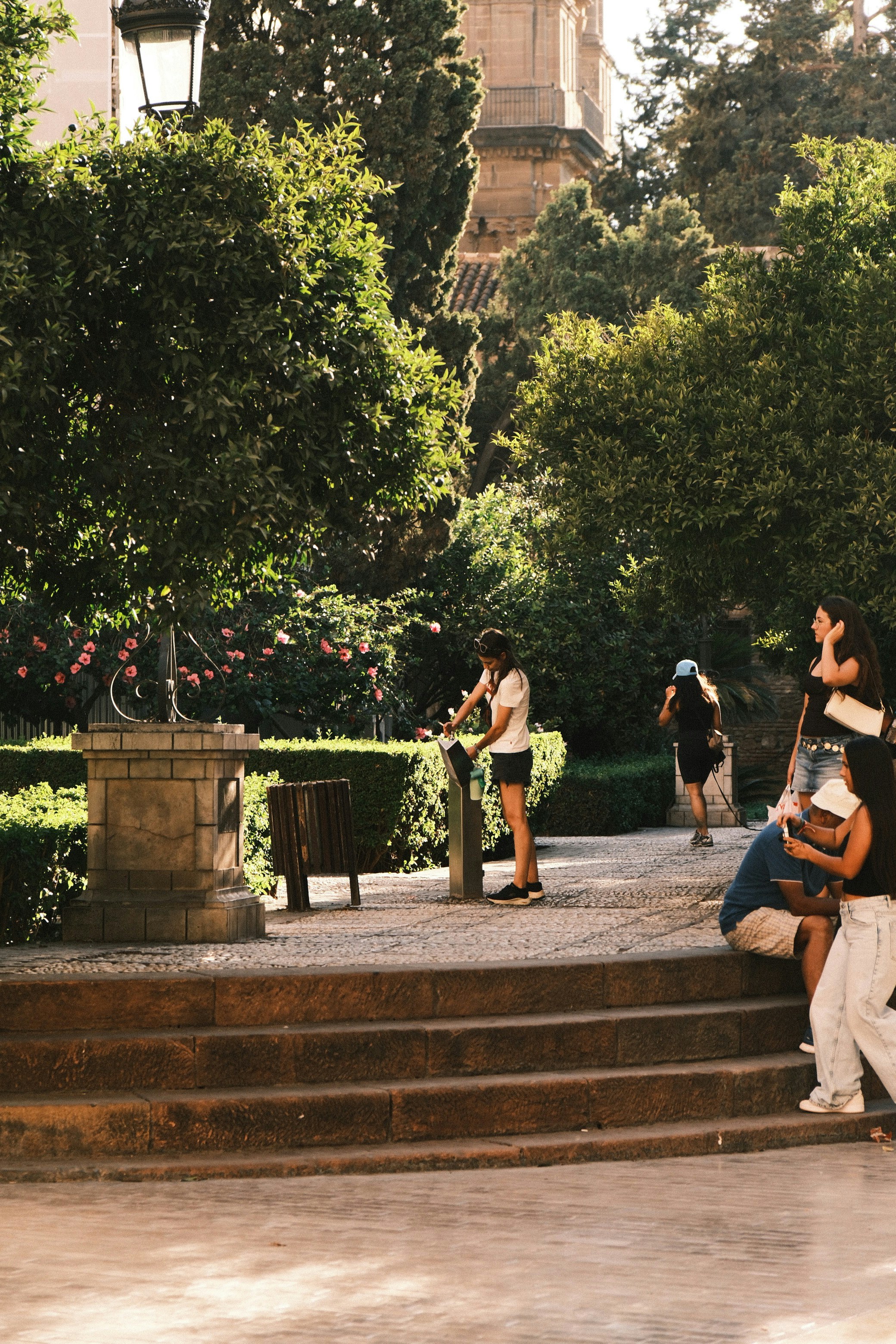 Sunlit Terrace: Friends Gather by the Garden Steps