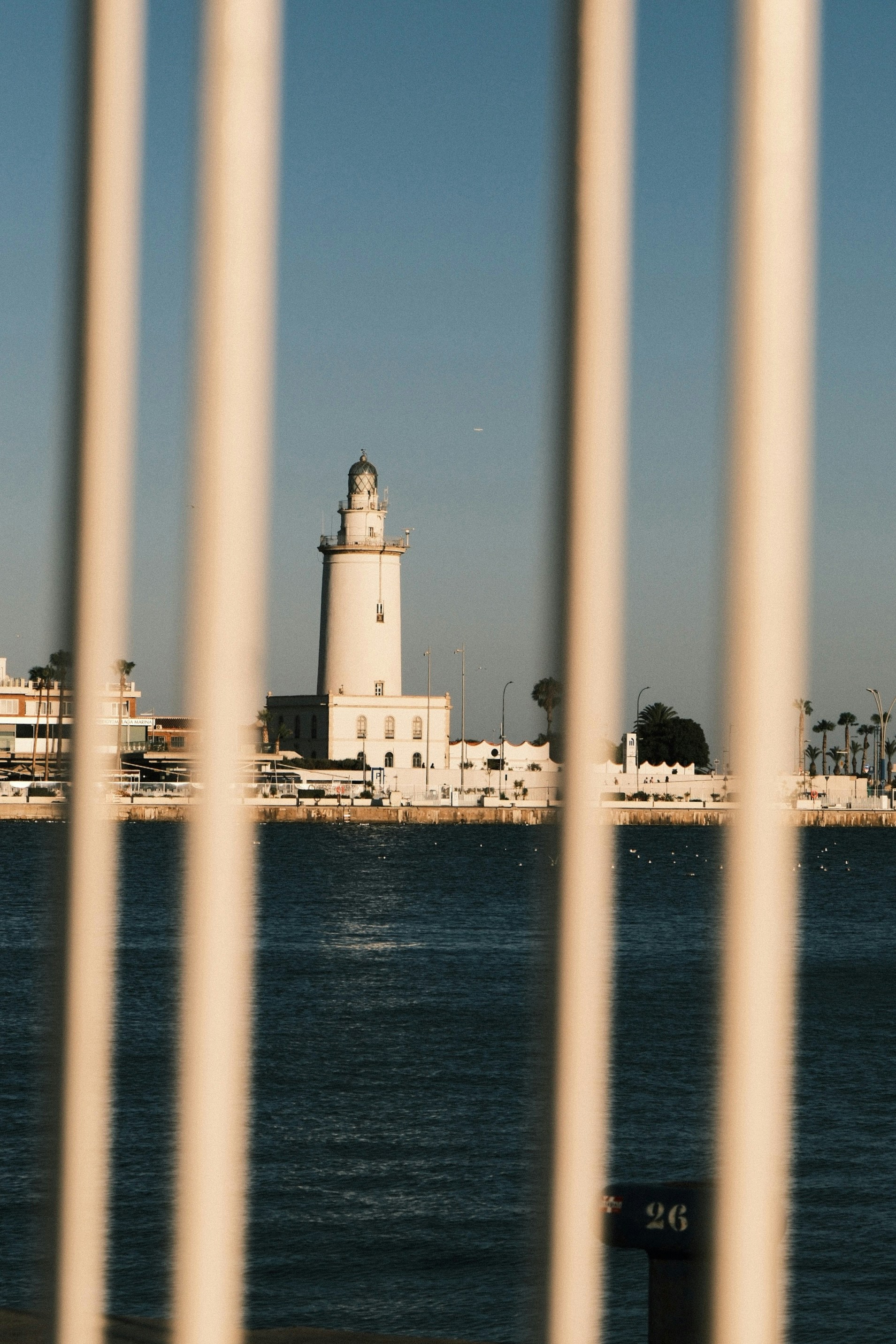 Lighthouse Between Vertical Bars at Seaside Wharf