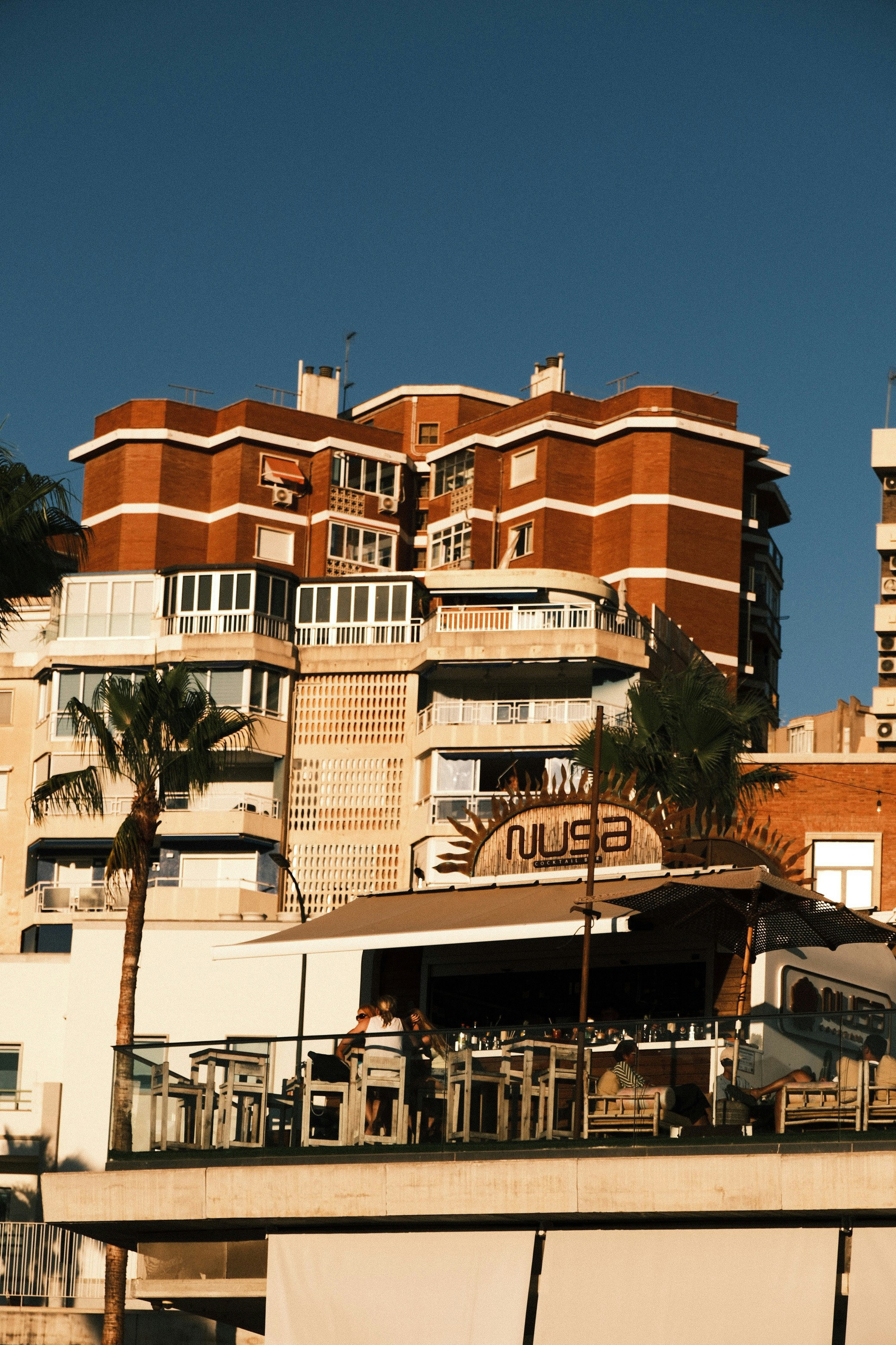 Balcony Café Under a Clear Coastal Sky