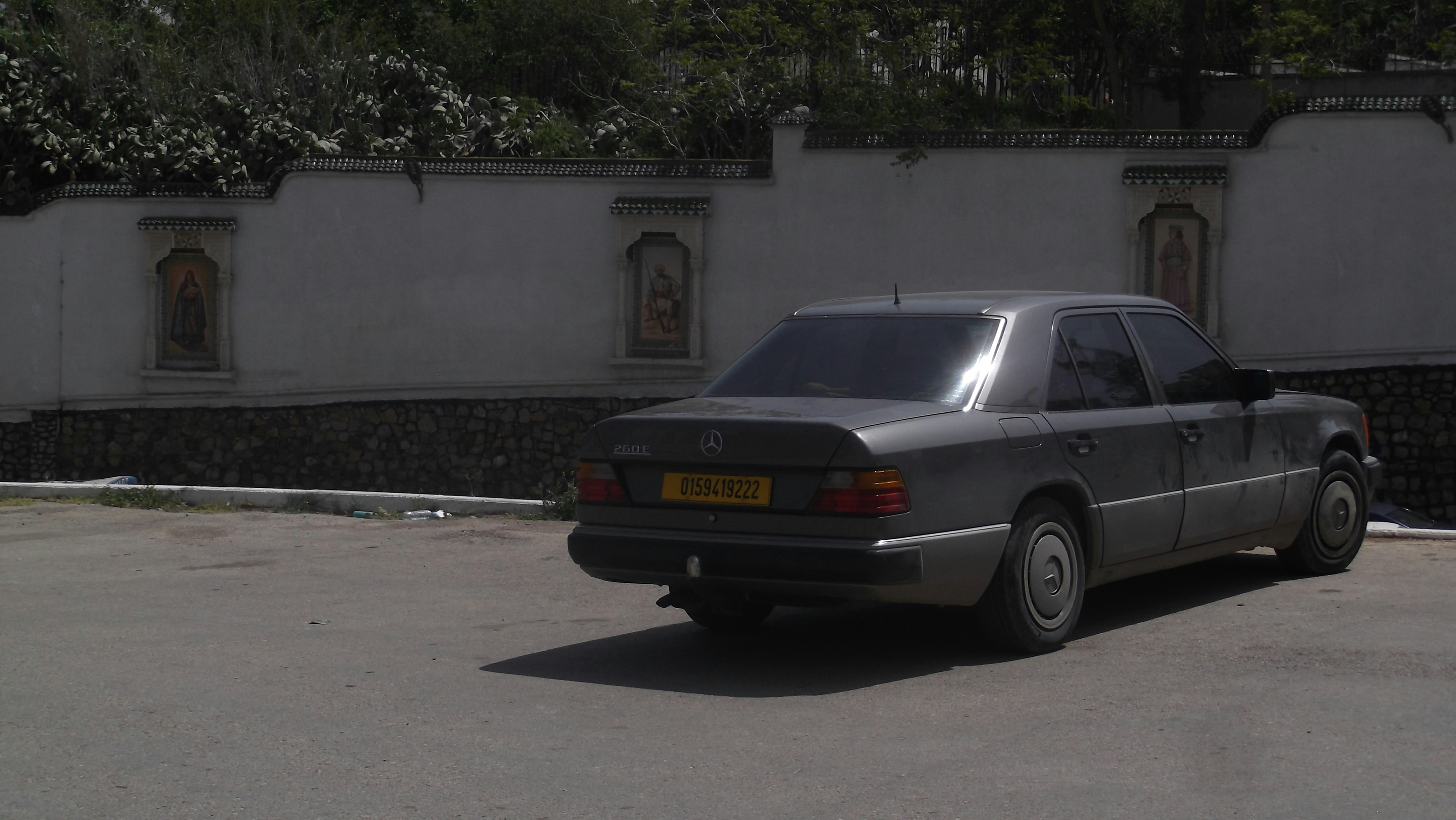 Midnight Classic: A Sedan Resting by a Quiet Courtyard Wall