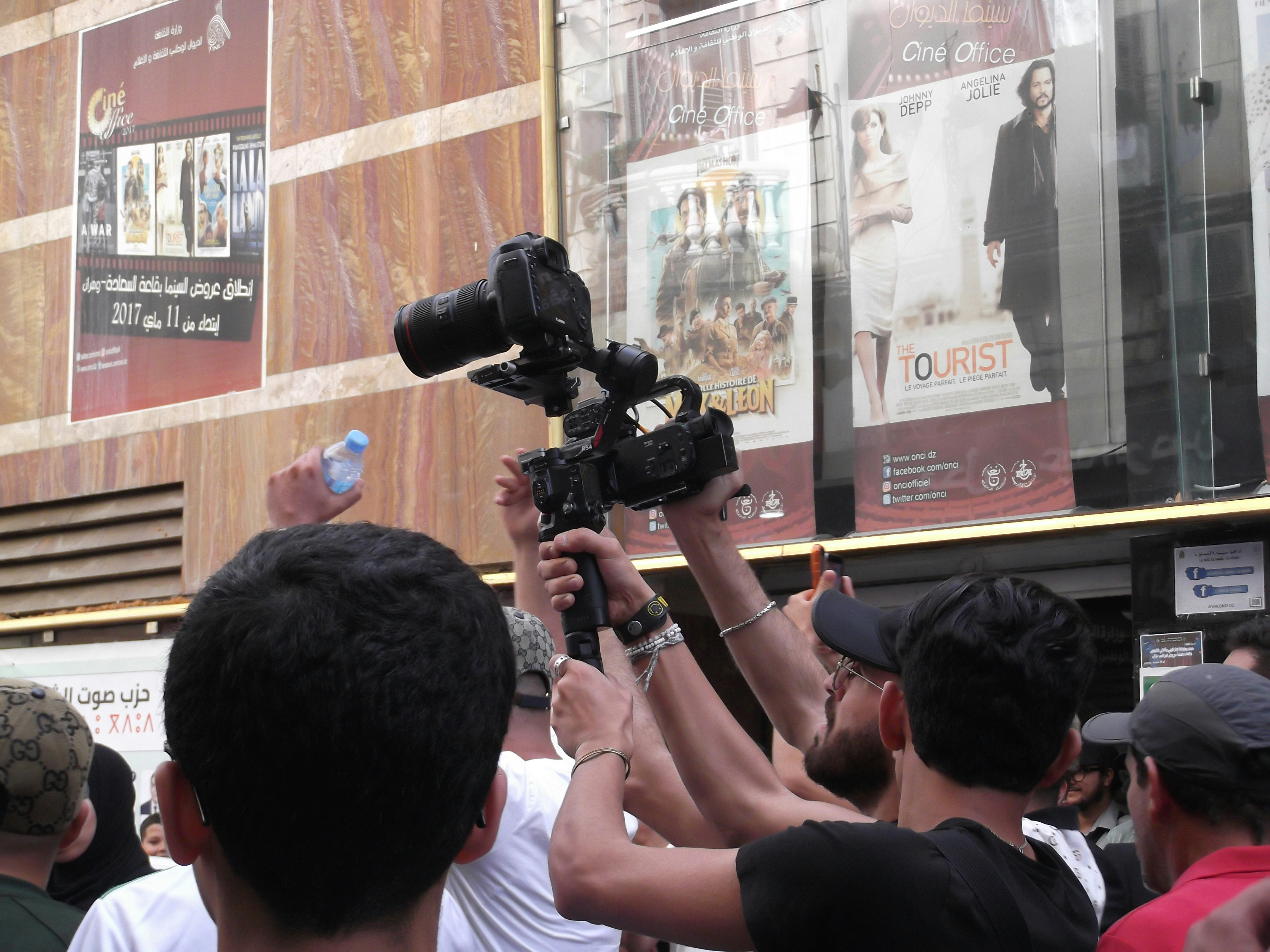 Crowd of Photographers Converging to Capture a City Moment