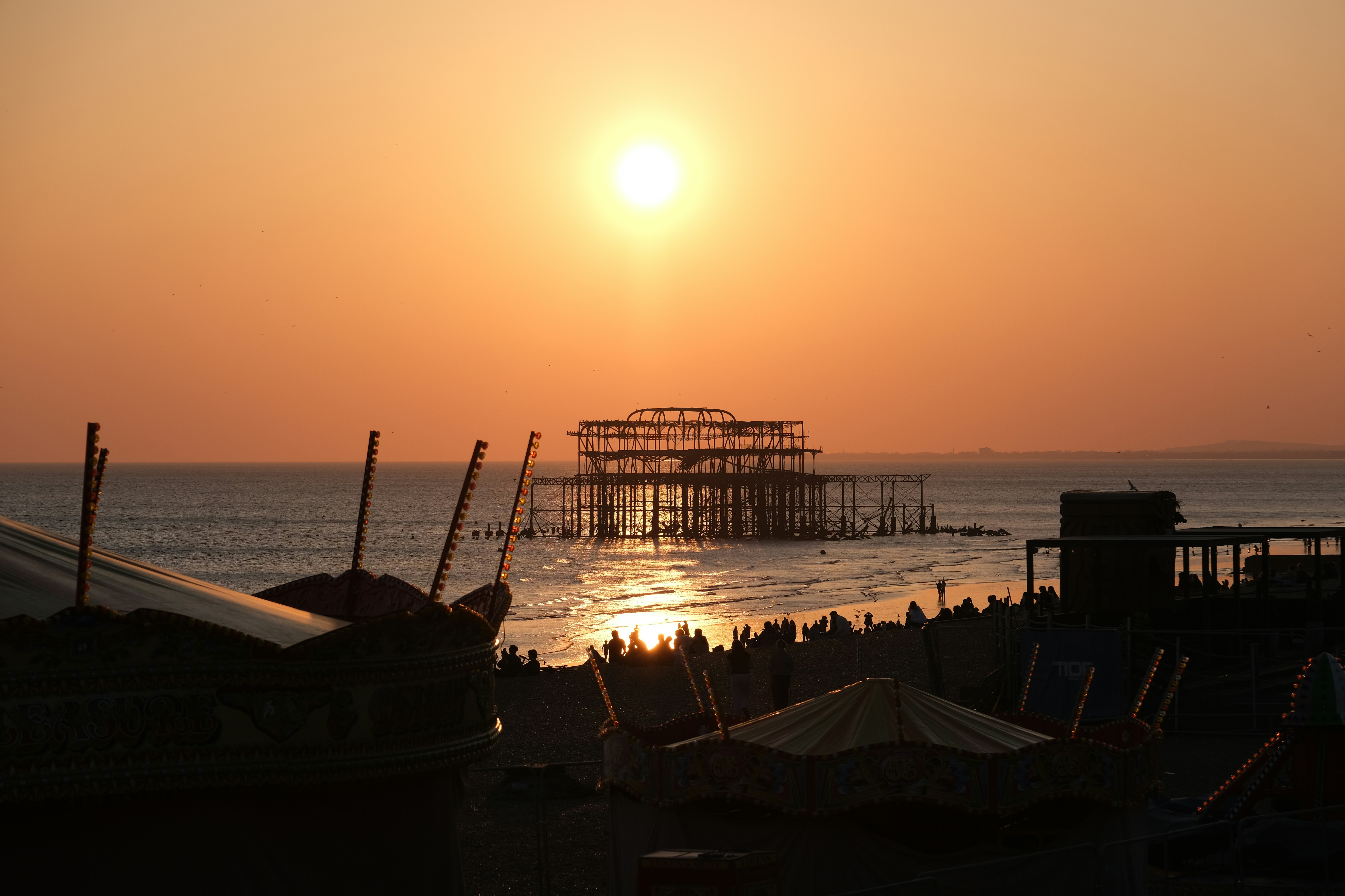 Sunset Pier Silhouette over a Quiet Beach