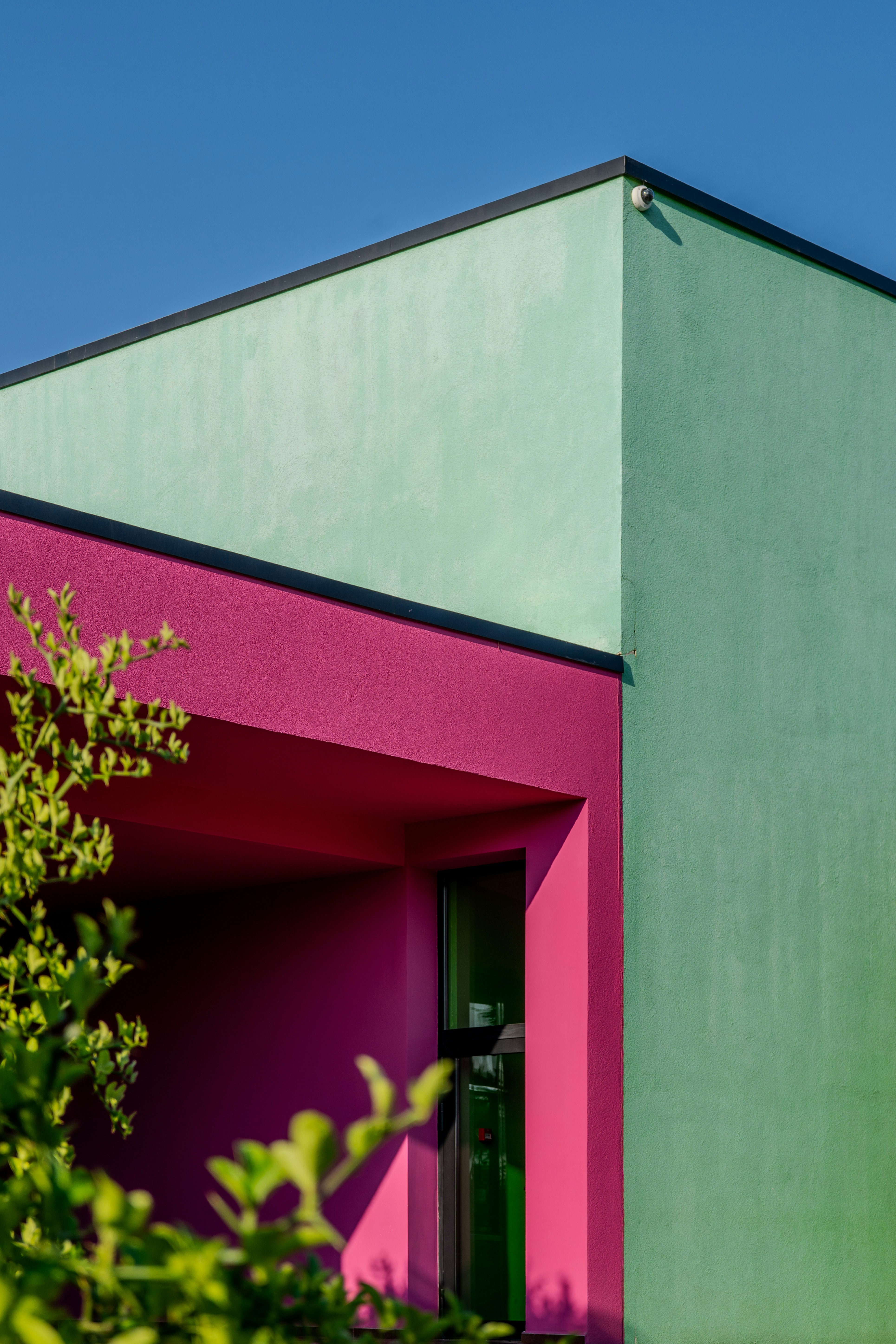 Neon Architecture: Bold Magenta Portal in Mint Wall