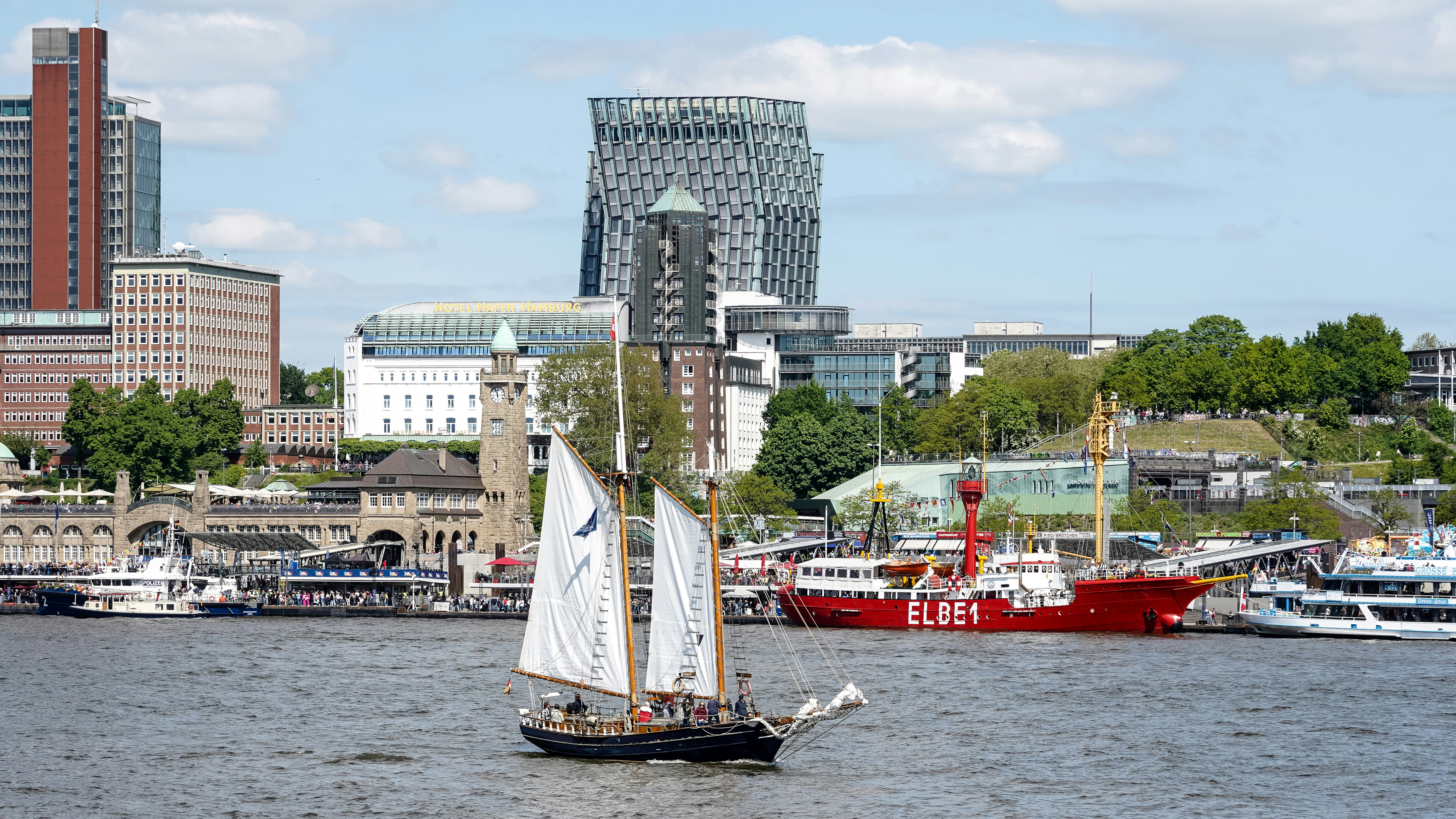 Sailboats and Red Rescue Boat Overlook the Riverfront