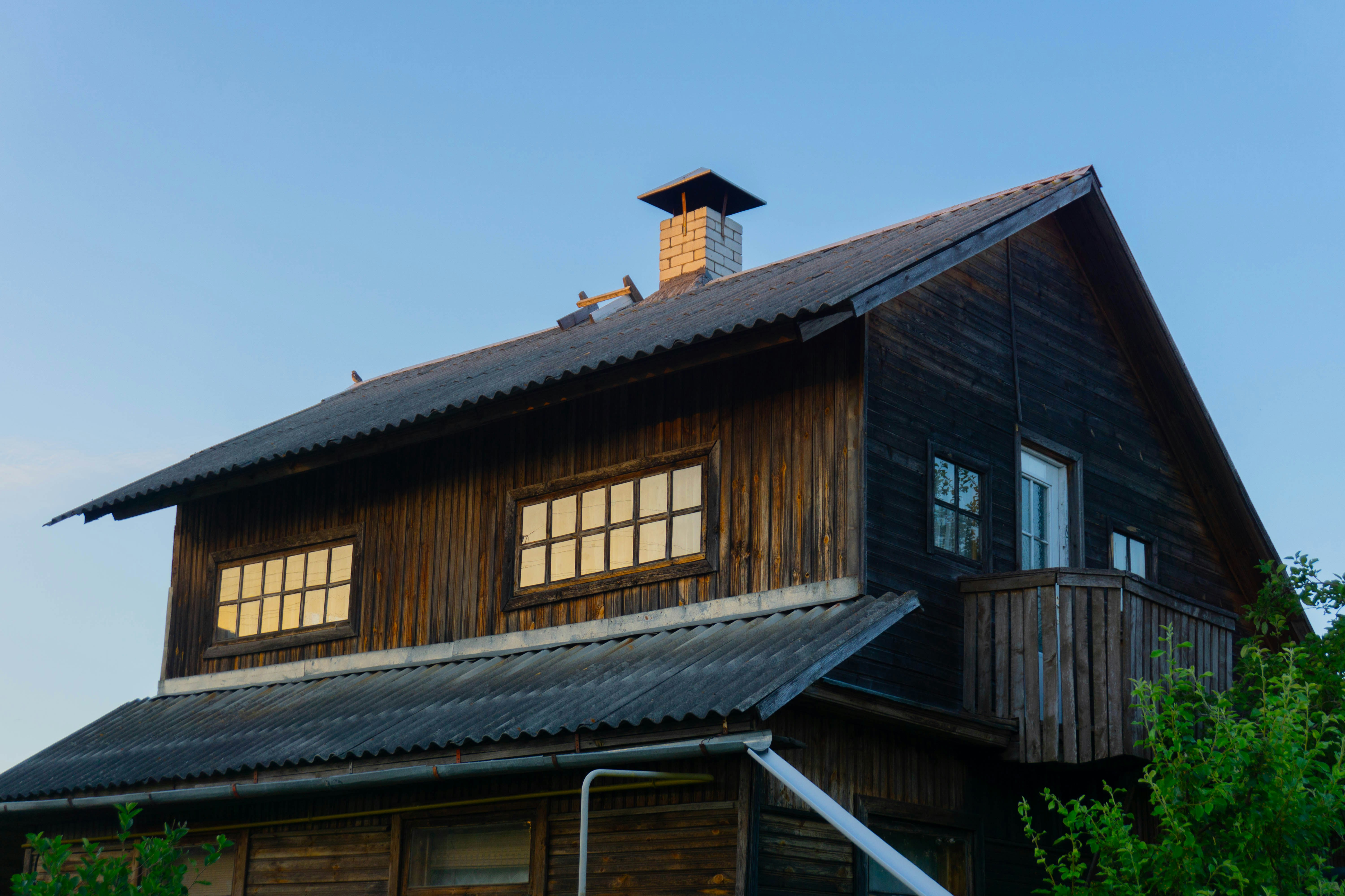 Weathered Wooden Chalet Under a Clear Sky