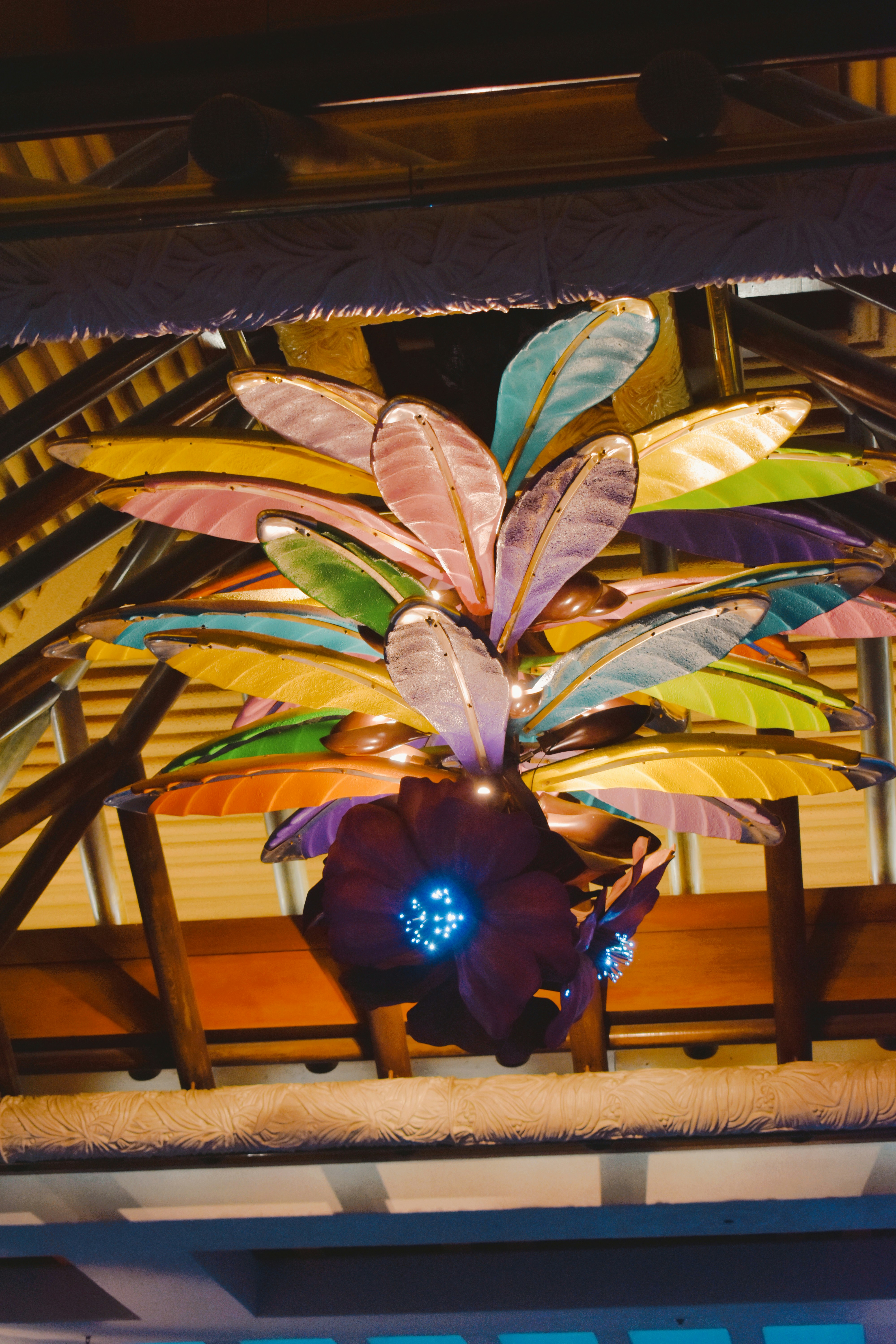 Vibrant Leaf-Fan Sculpture Under Warm Theater Lighting