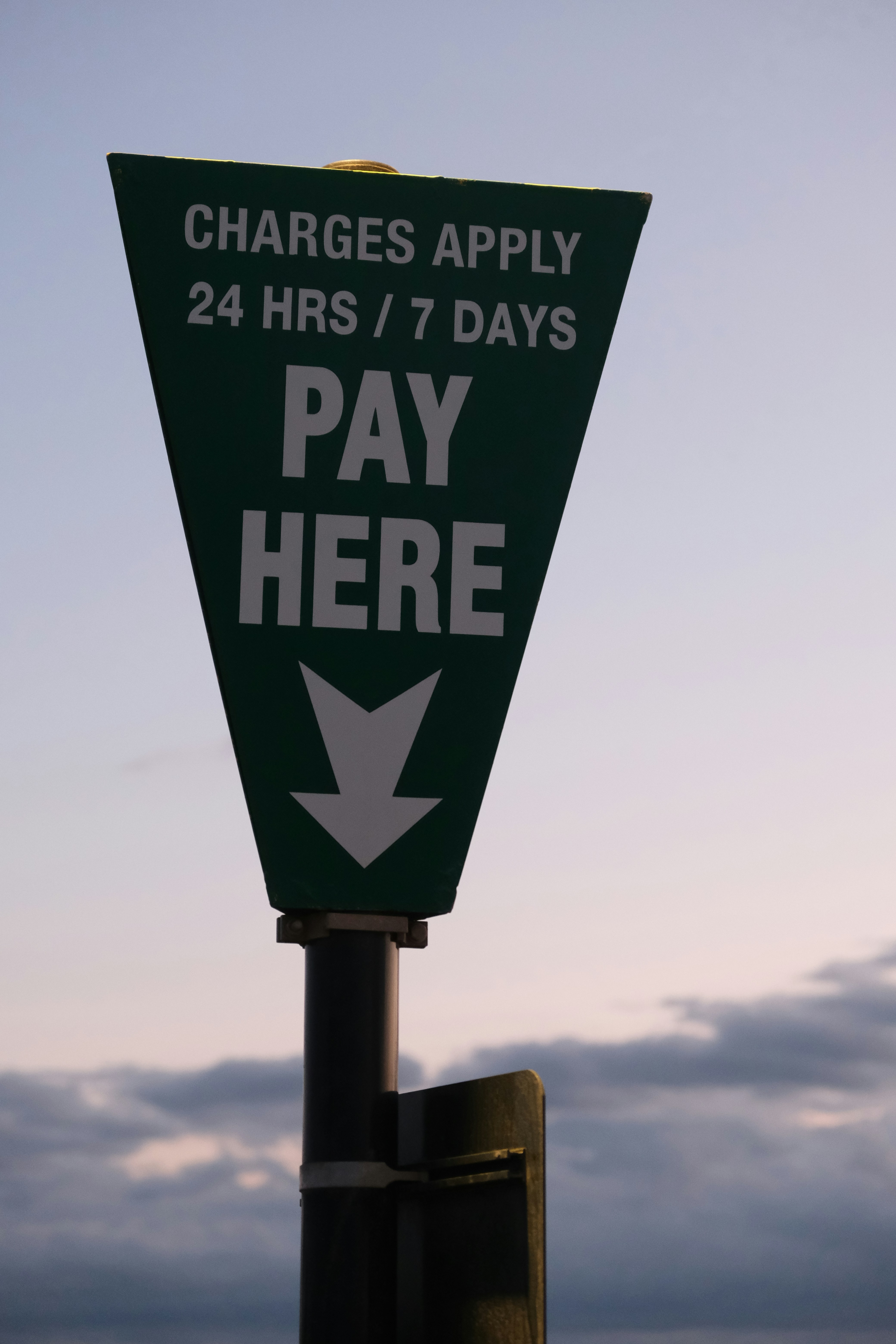 Pay Here Arrow Pointing the Way: A Sign Against Twilight
