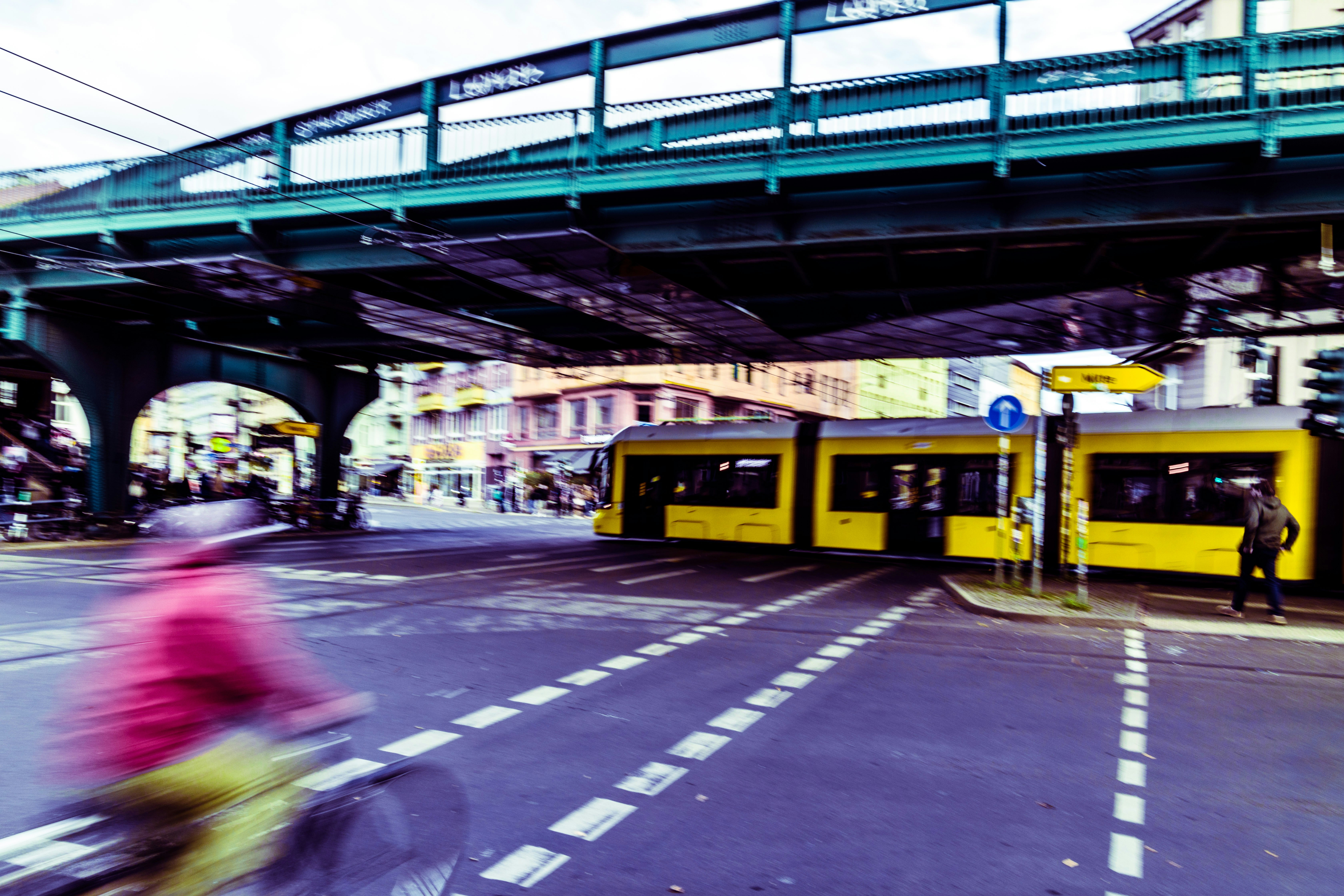 Blurred Urban Pulse: Yellow Trams and a Quiet Bicyclist