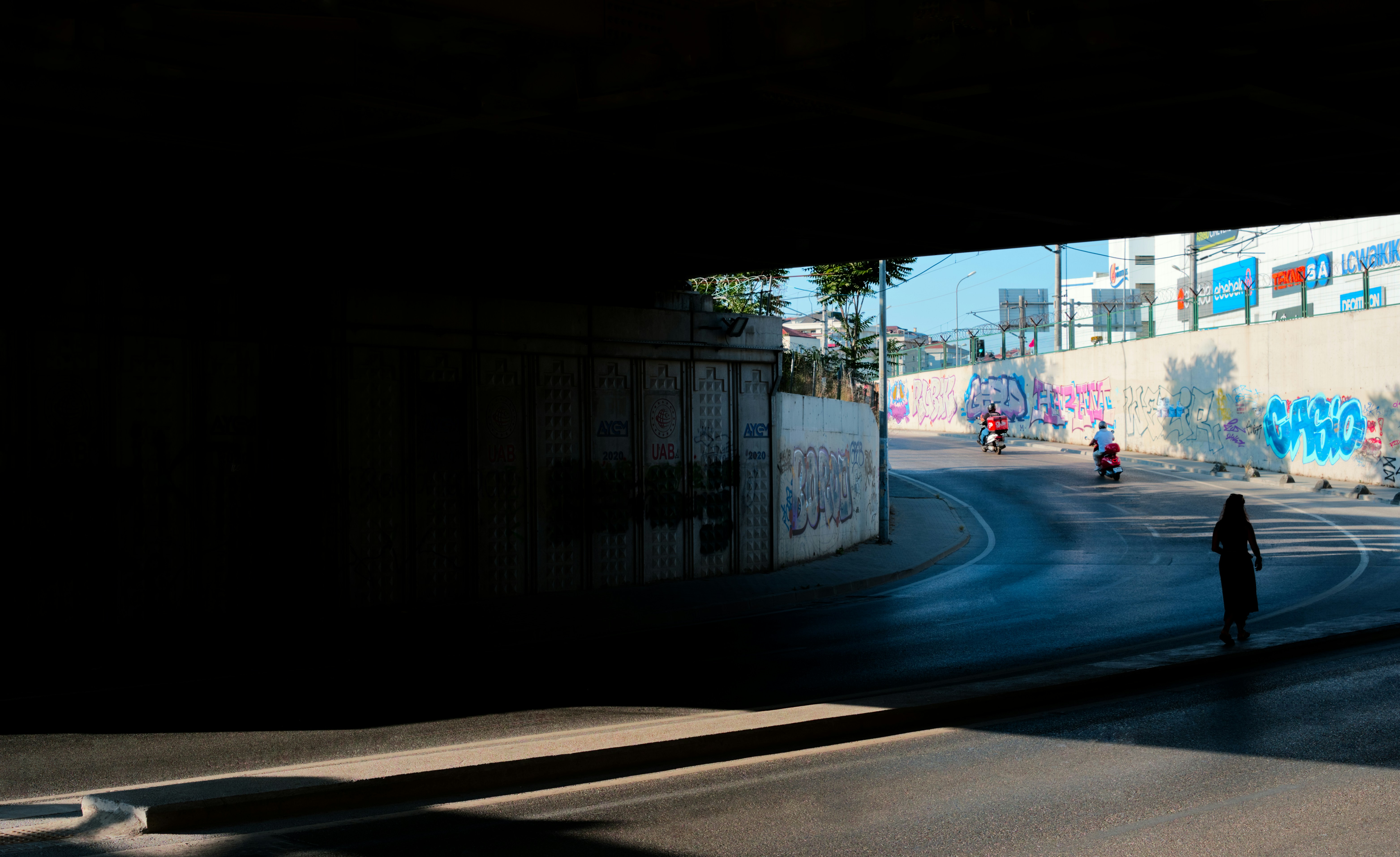 Underpass Light: A Quiet Street Emerges from Shadow