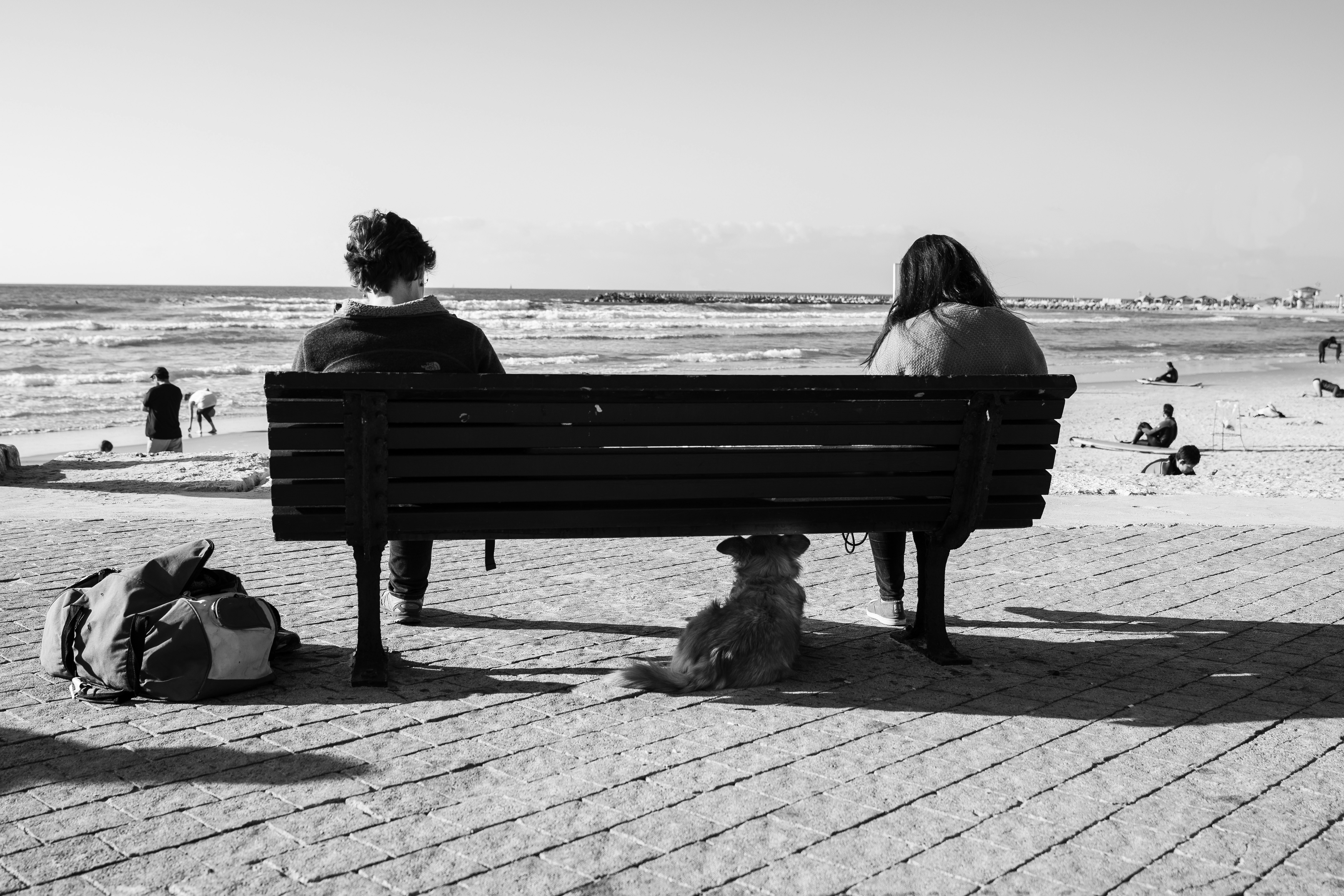 Two Silhouettes on a Seaside Bench