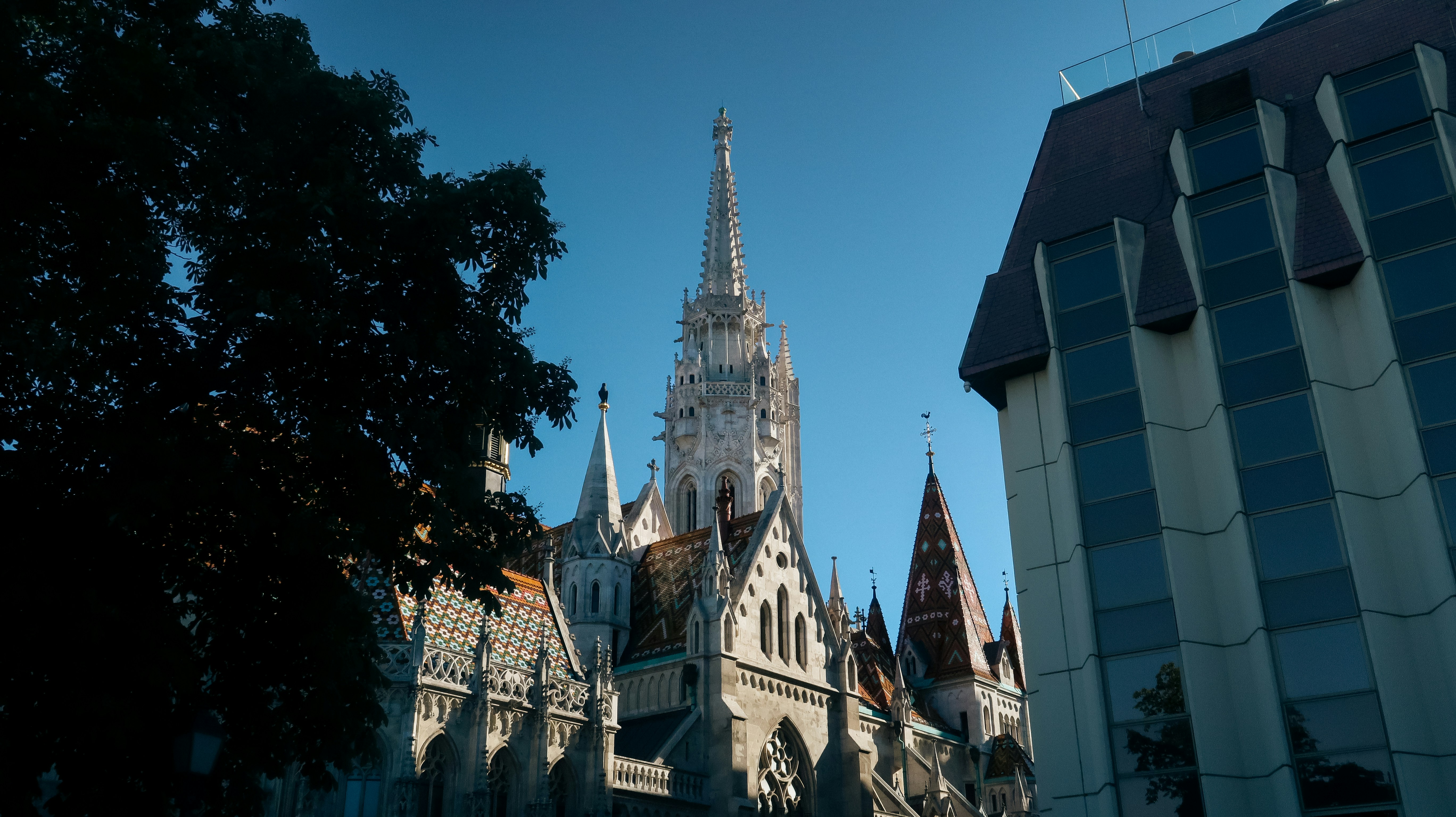 Gothic Spire Surrounded by Modern Facades