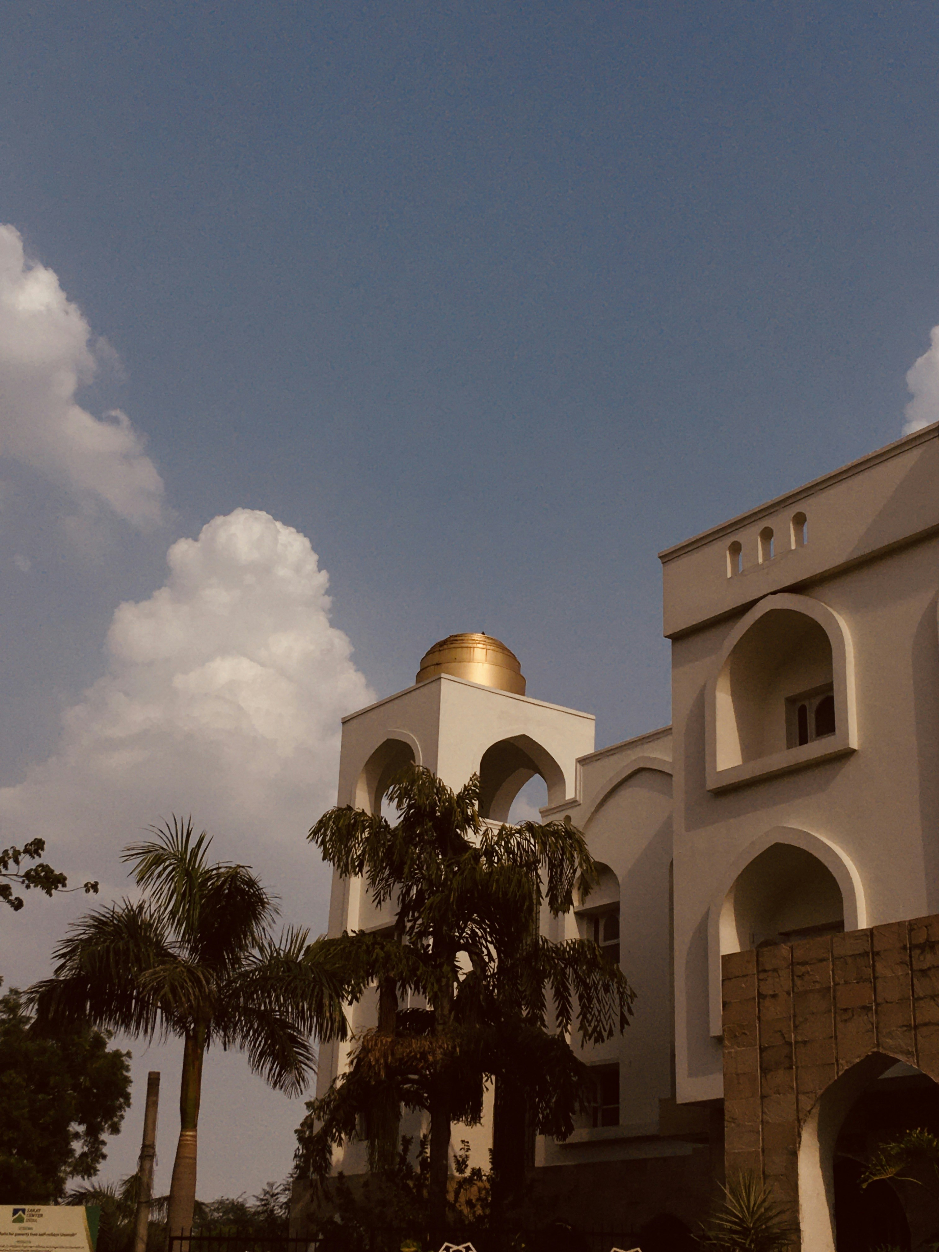 Arched Facade Under a Clear Sky with Golden Dome Crown