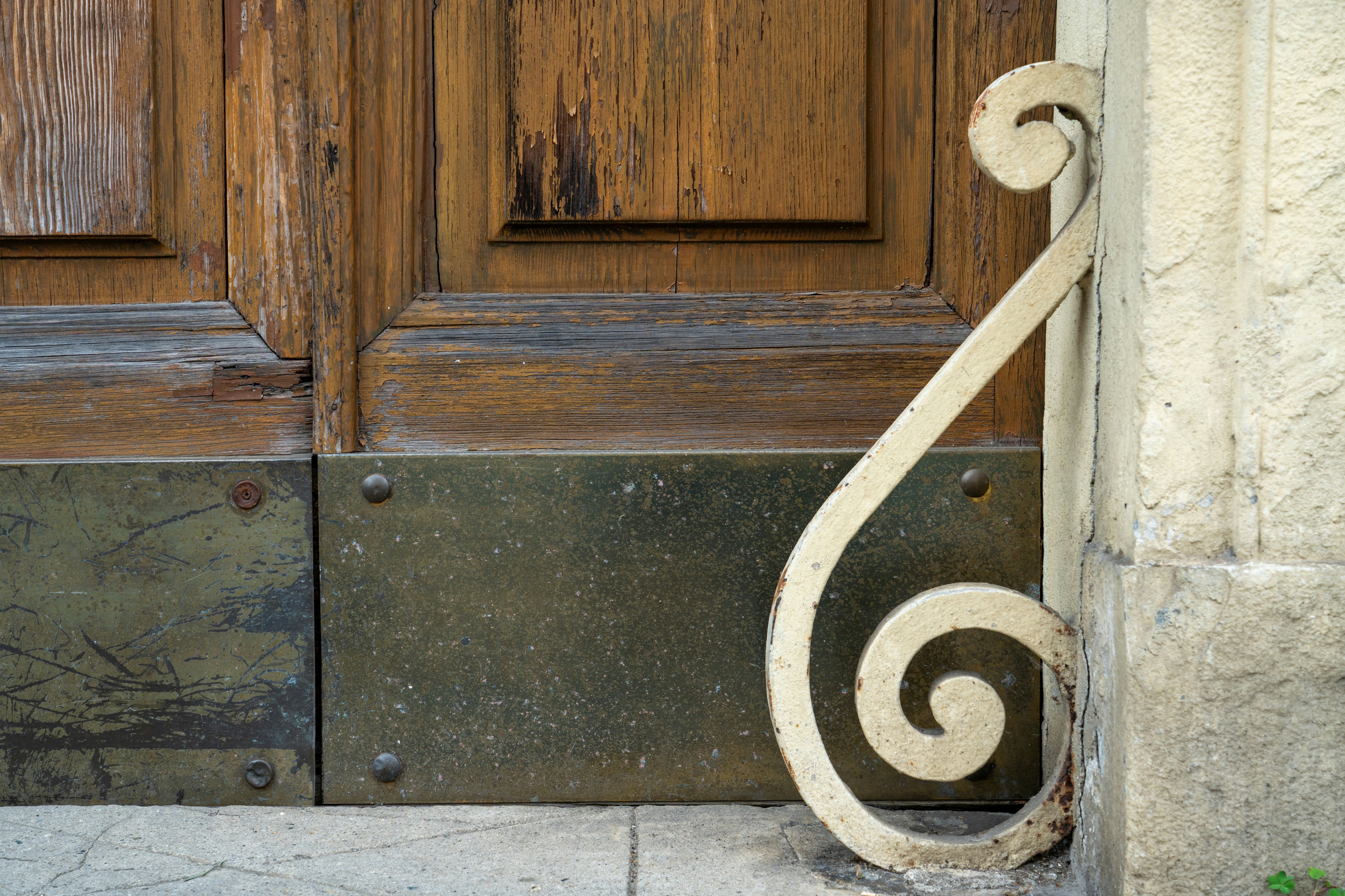 Old Door with Ironwork under a Weathered Wooden Panel
