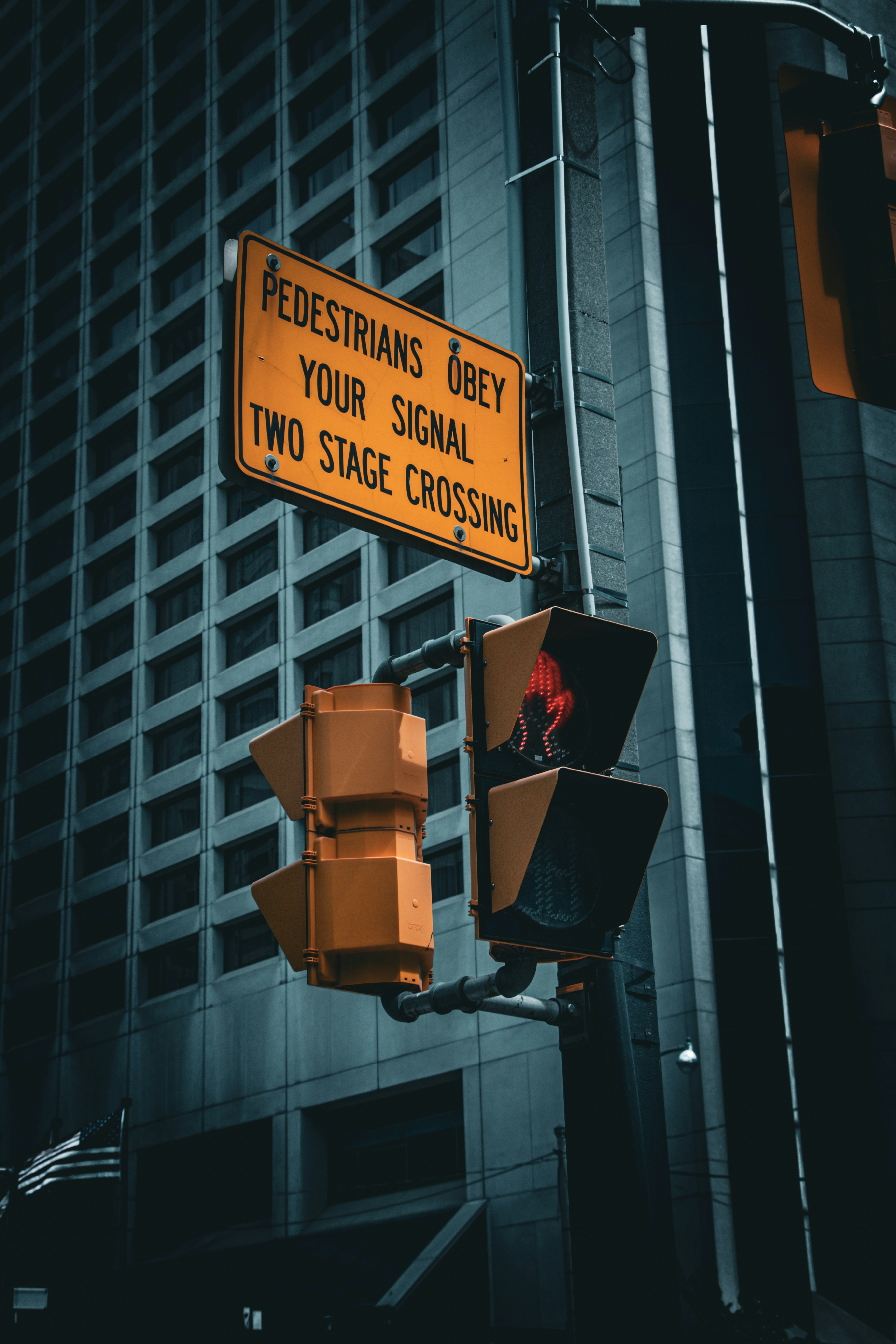Urban Signal: Neon Orange at a Two-Stage Crosswalk