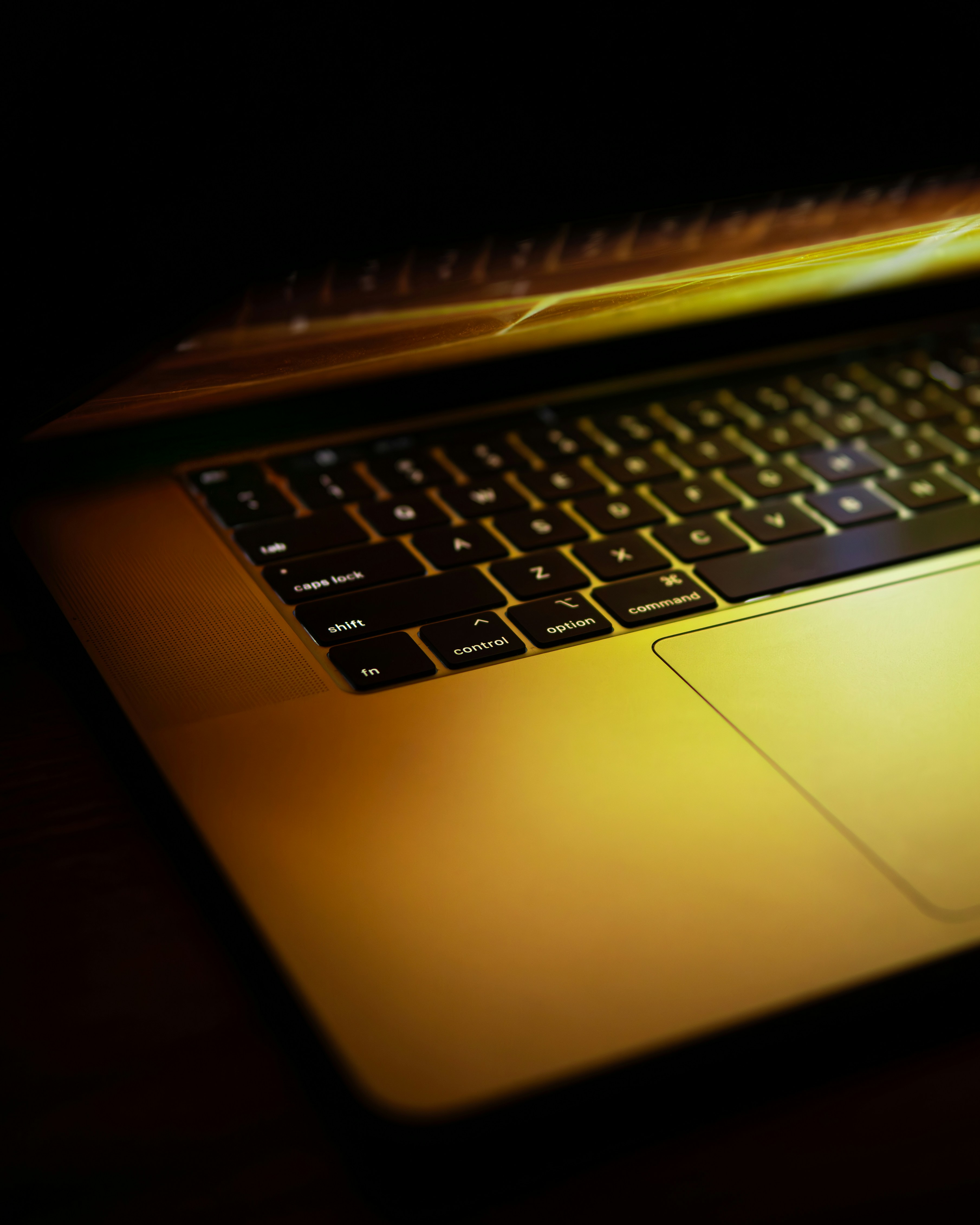 Golden Glow: A Close-Up of a Laptop Keyboard Bathed in Warm Light