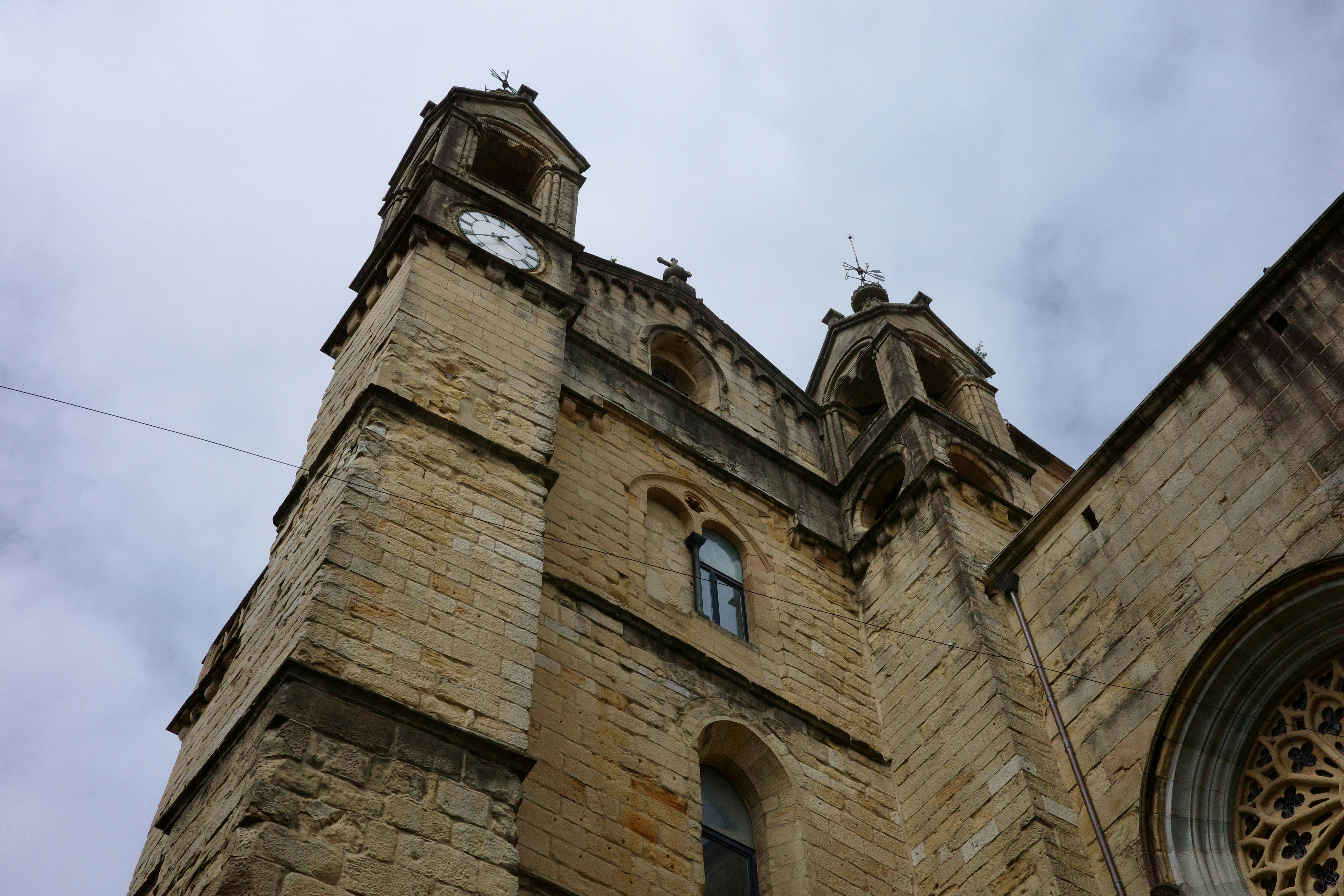 Stone Bell Tower Reaching Toward a Cloudy Sky