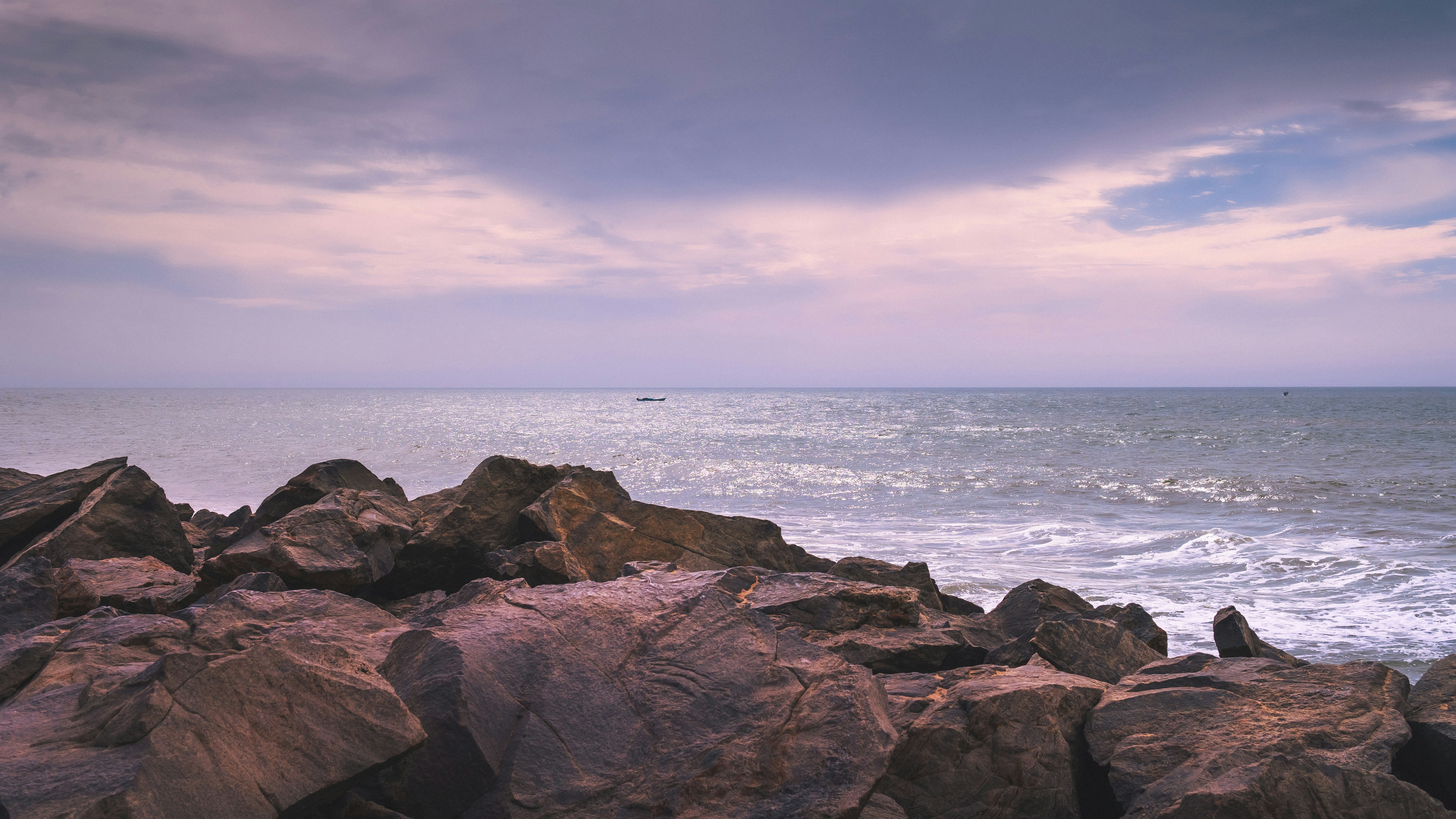 Rugged shoreline under a pastel dusk sky